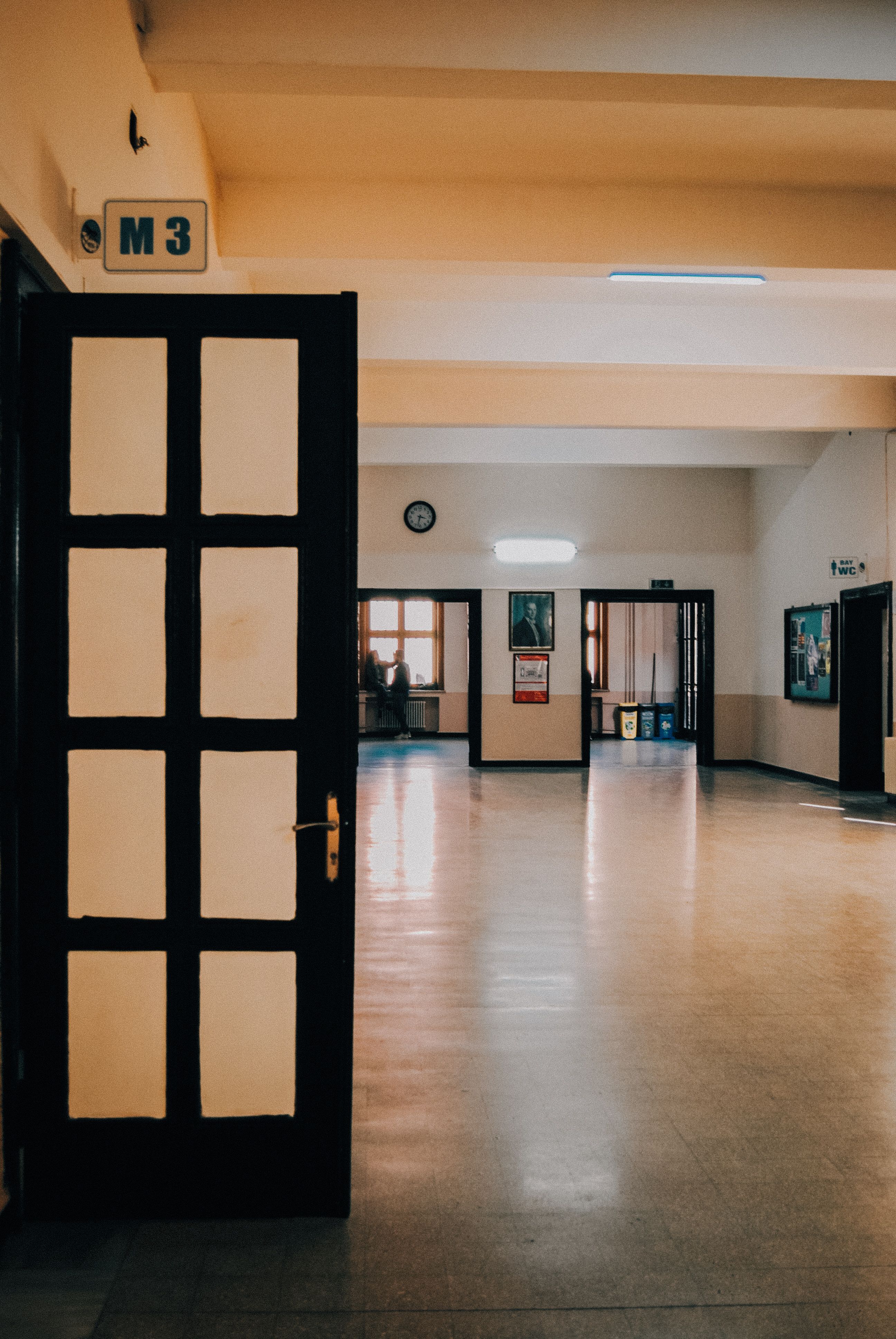 Quiet School Hallway with Open Door and Sign · Free Stock Photo