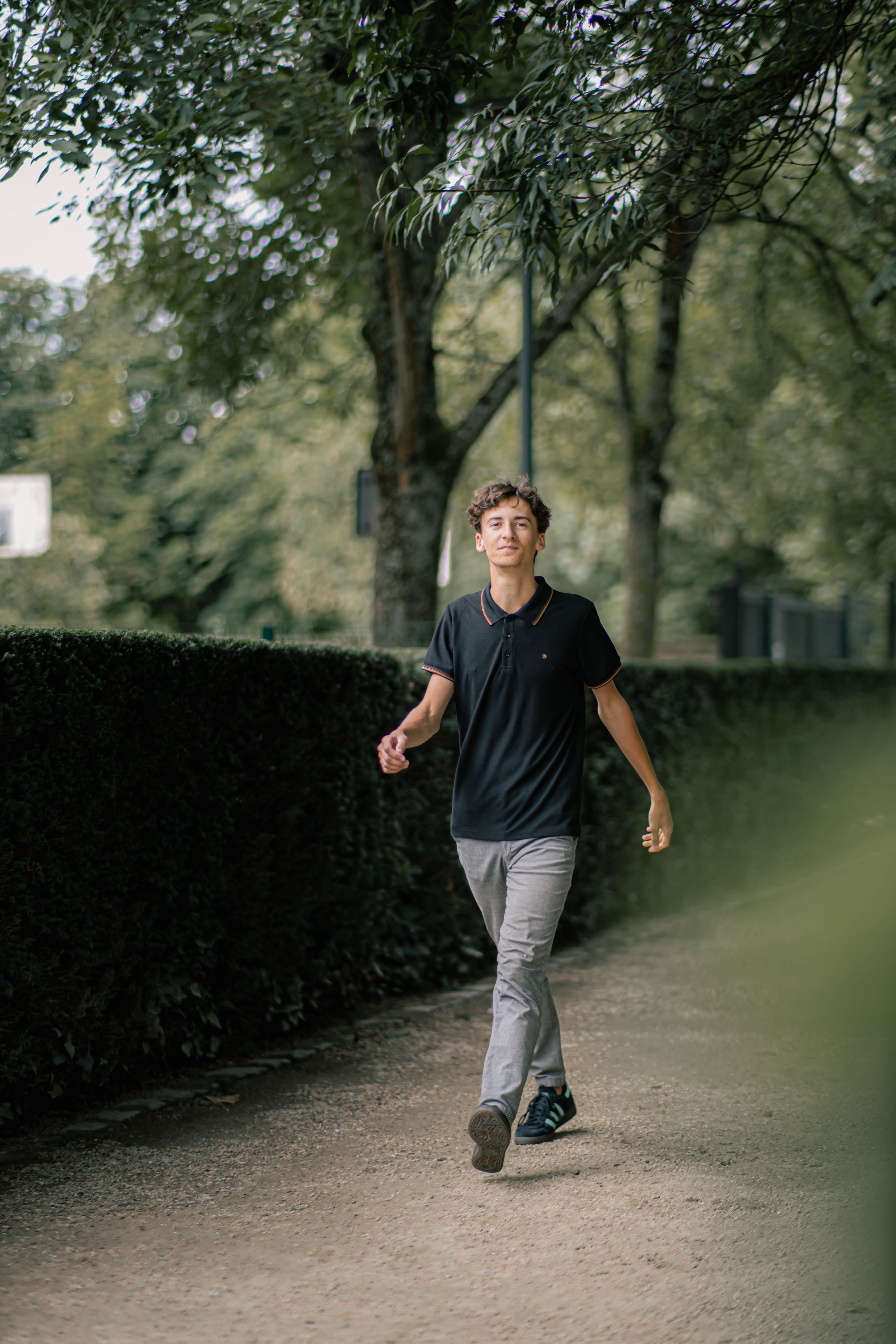 Young Man Walking in Park During Summer · Free Stock Photo