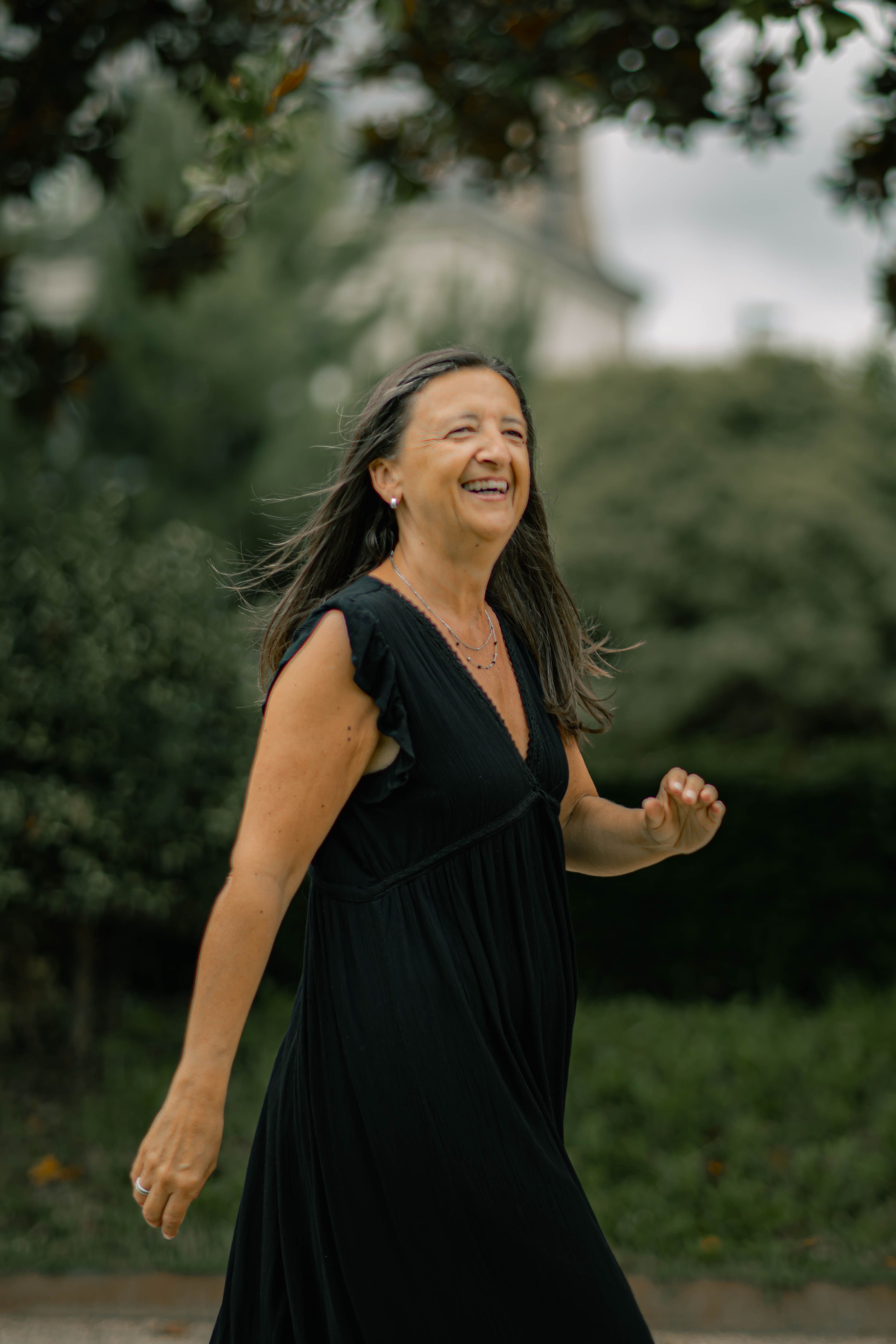 Joyful Woman Strolling in Green Park · Free Stock Photo