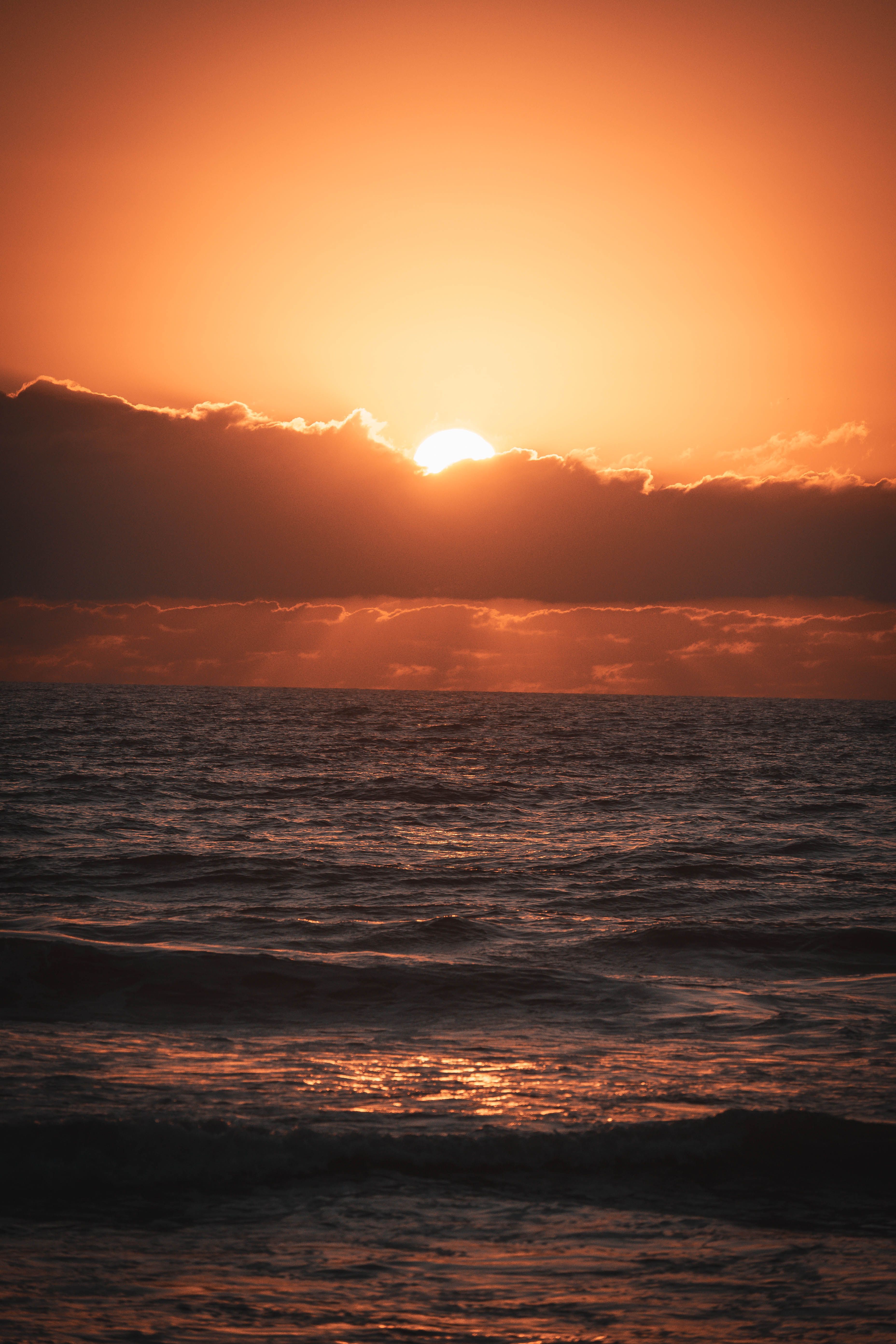 Dramatic red sunset over waving ocean · Free Stock Photo