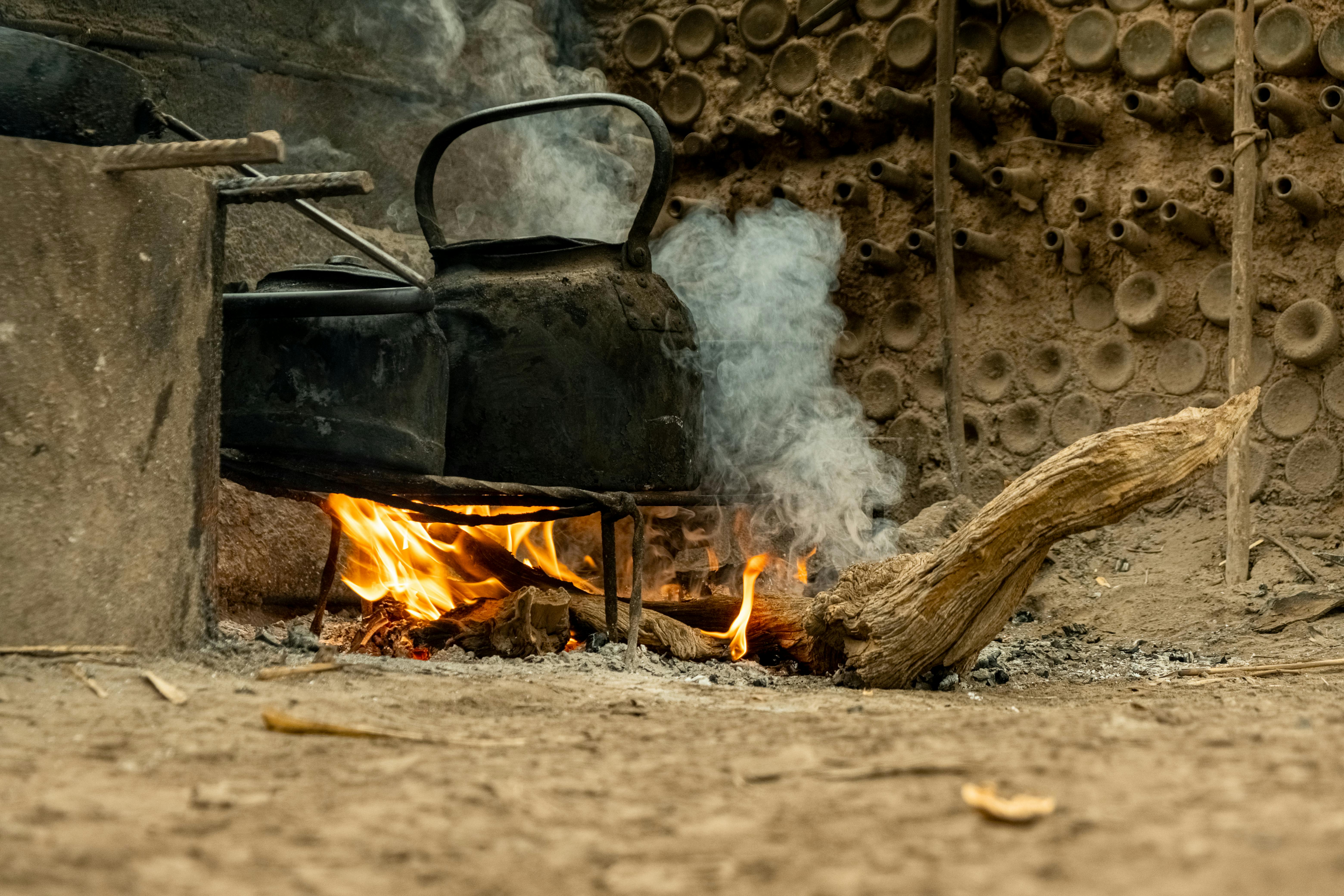 Rustic Outdoor Cooking with Fire and Smoke · Free Stock Photo