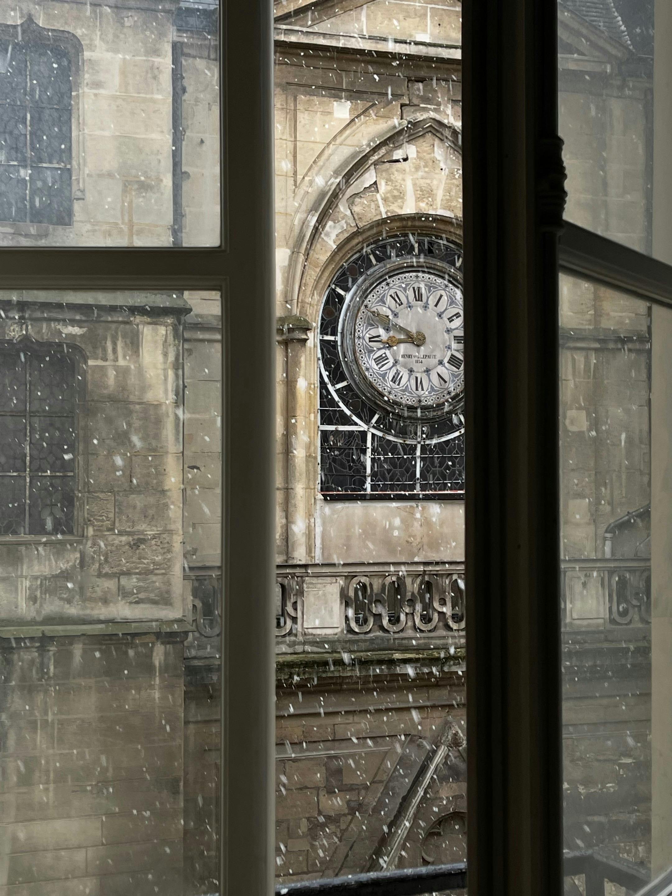 Historic Clock Tower View with Falling Snow · Free Stock Photo