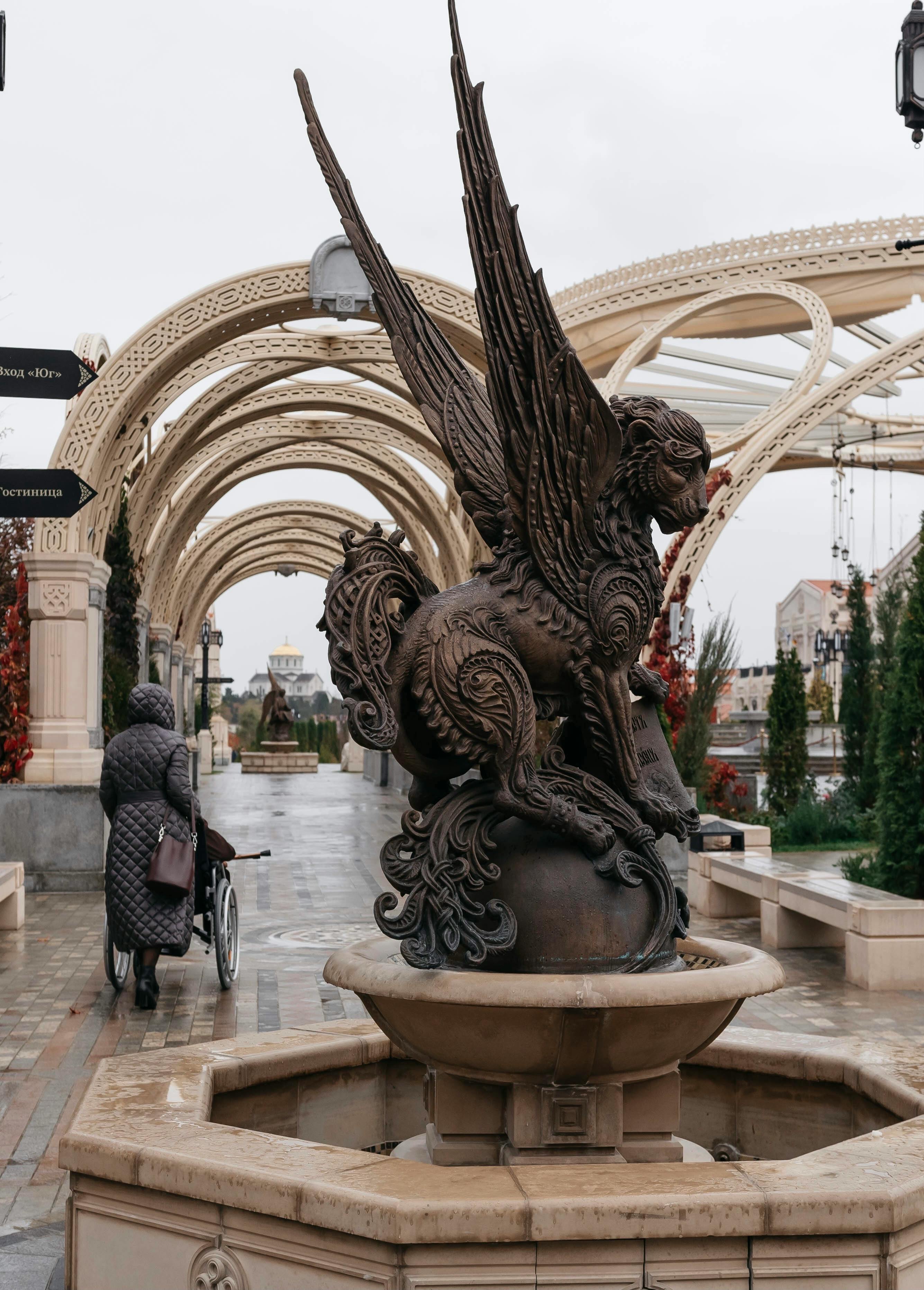 Elegant Gryphon Sculpture in Urban Park Setting · Free Stock Photo