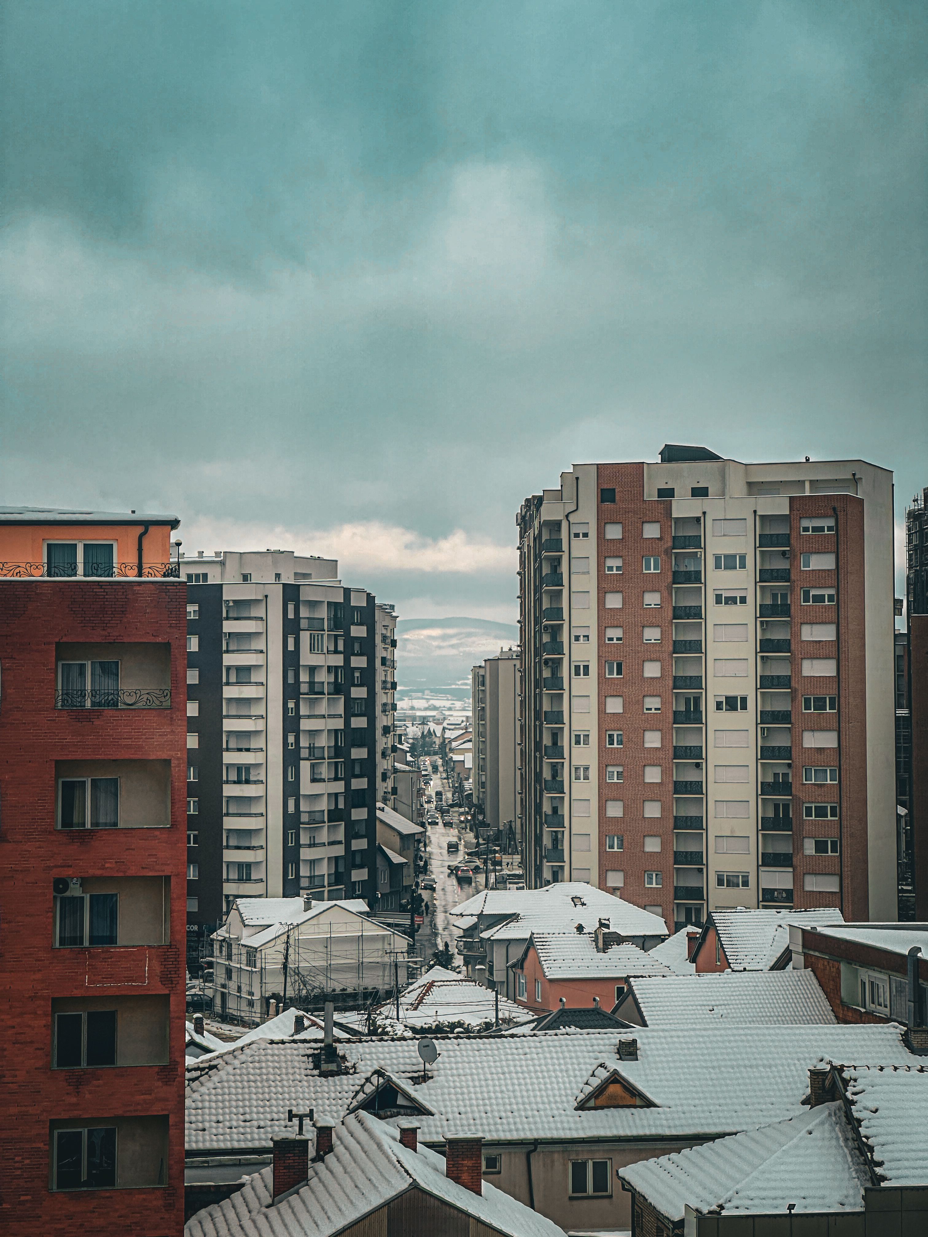 Urban Winter Cityscape with Snow-Laden Roofs · Free Stock Photo
