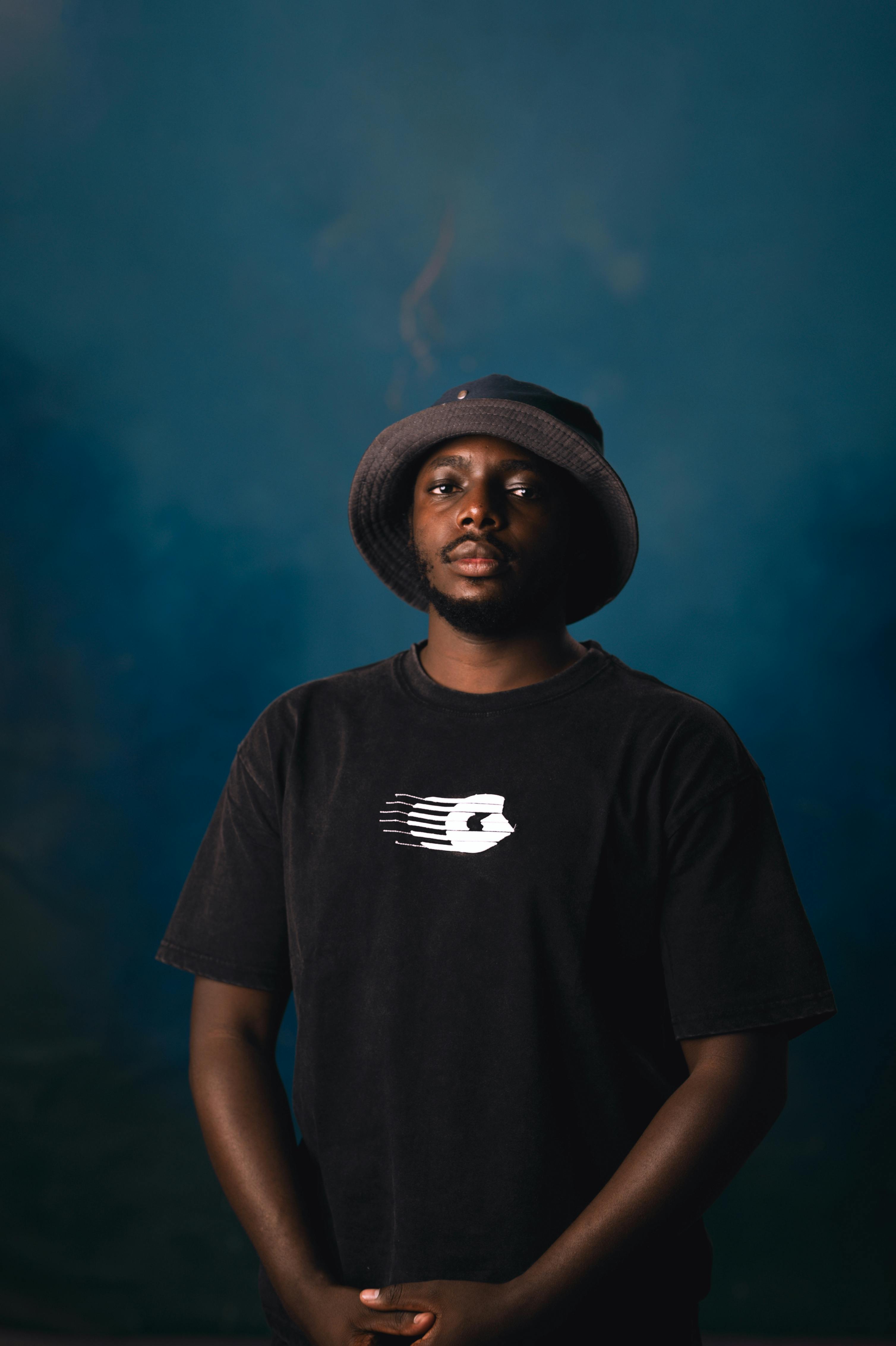 Portrait of a Man in a Bucket Hat with Blue Background · Free Stock Photo