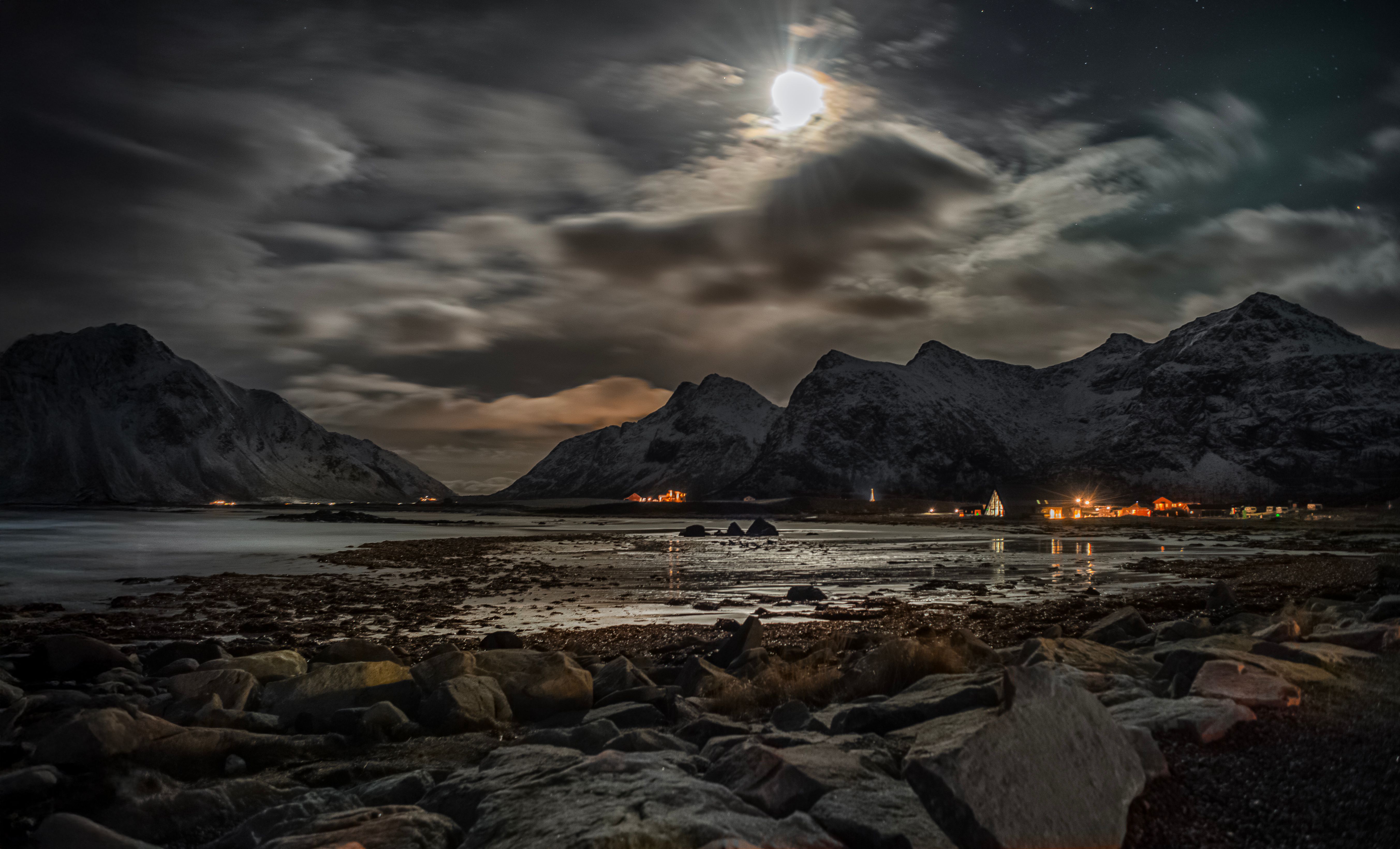 Moonlit Mountain Landscape Under a Cloudy Night Sky · Free Stock Photo