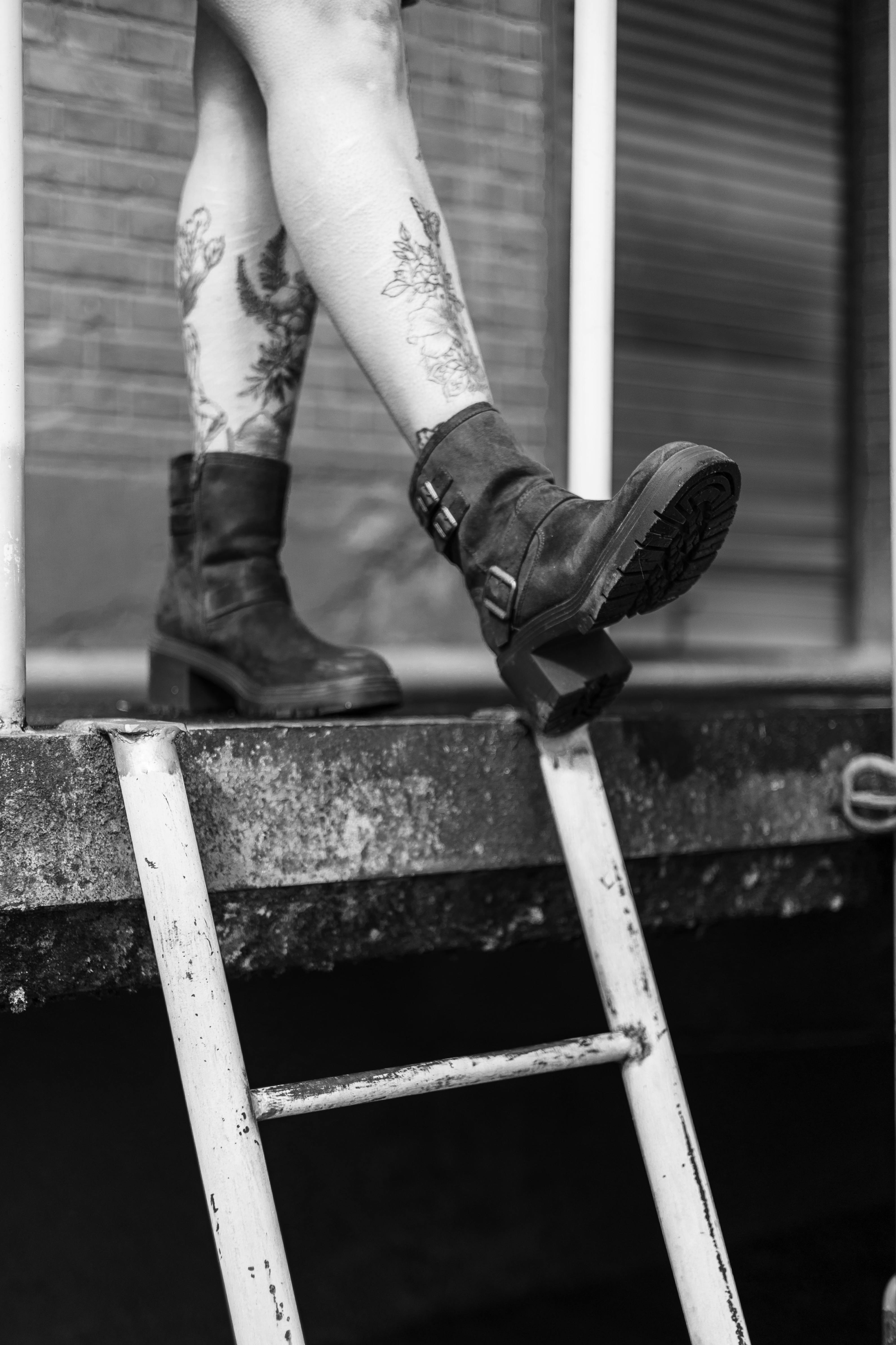 Stylish Boot on Ladder in Urban Setting · Free Stock Photo