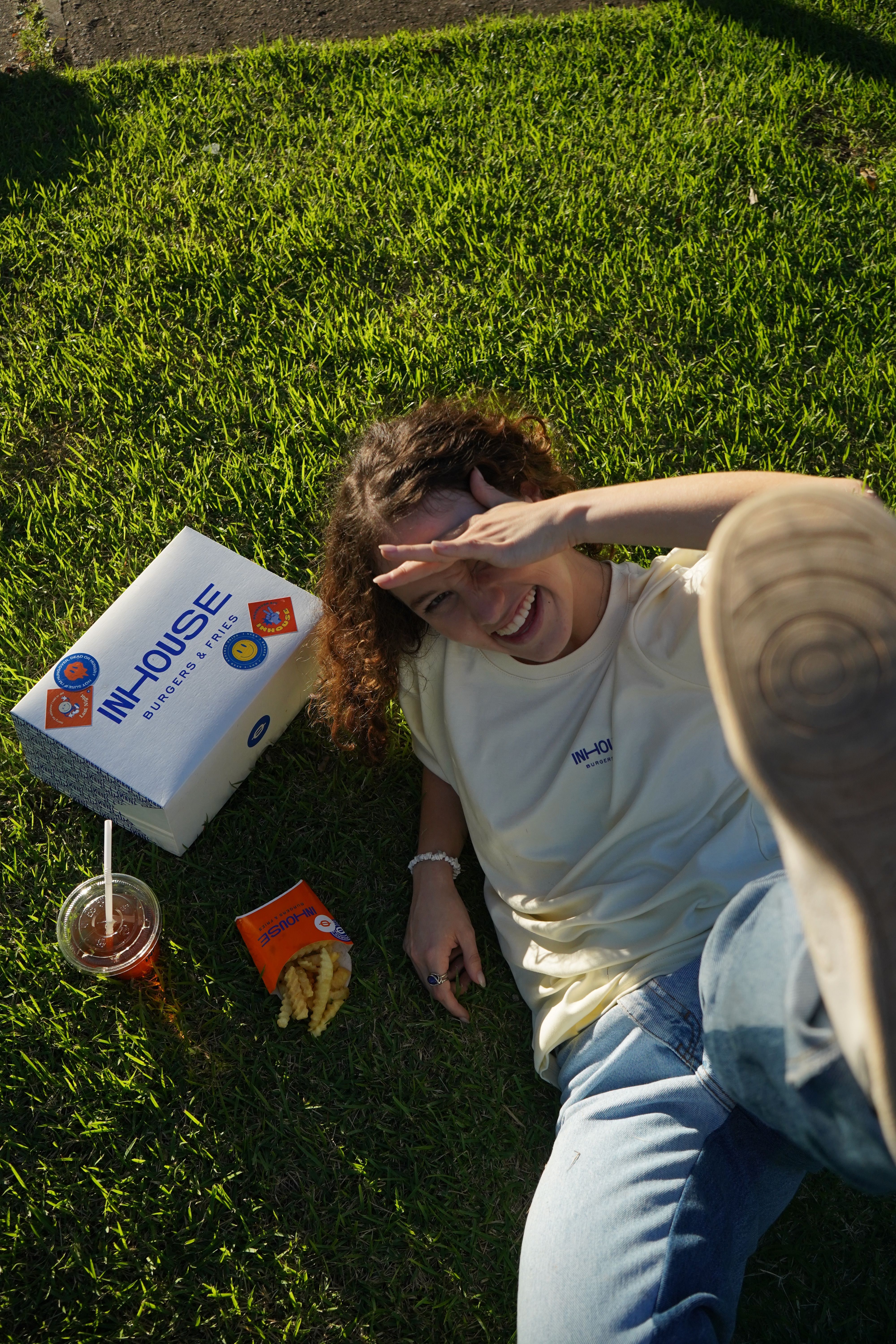 Young Woman Relaxing with Snacks on Grass · Free Stock Photo