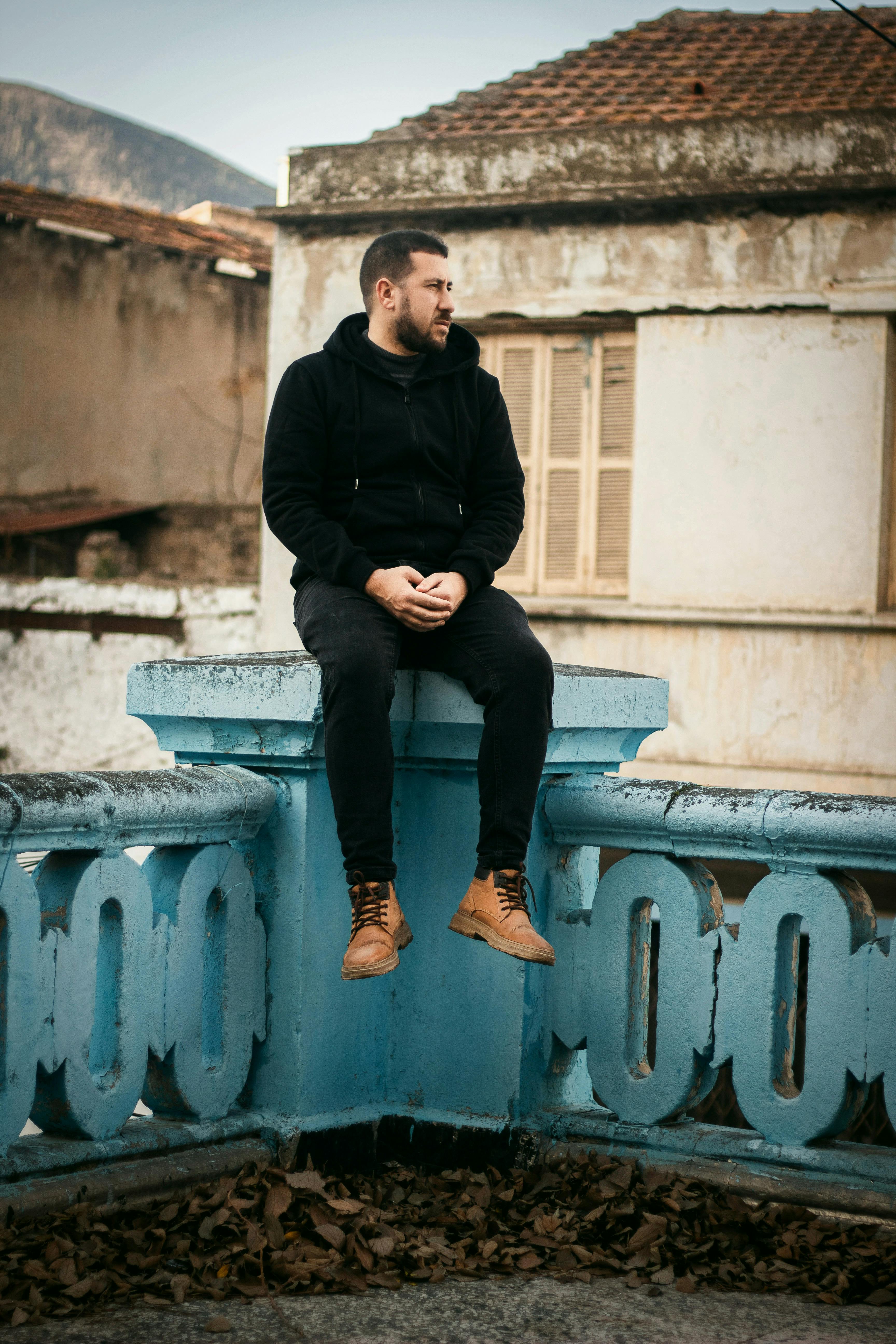 Man Sitting on Blue Balcony in Collo, Algeria · Free Stock Photo