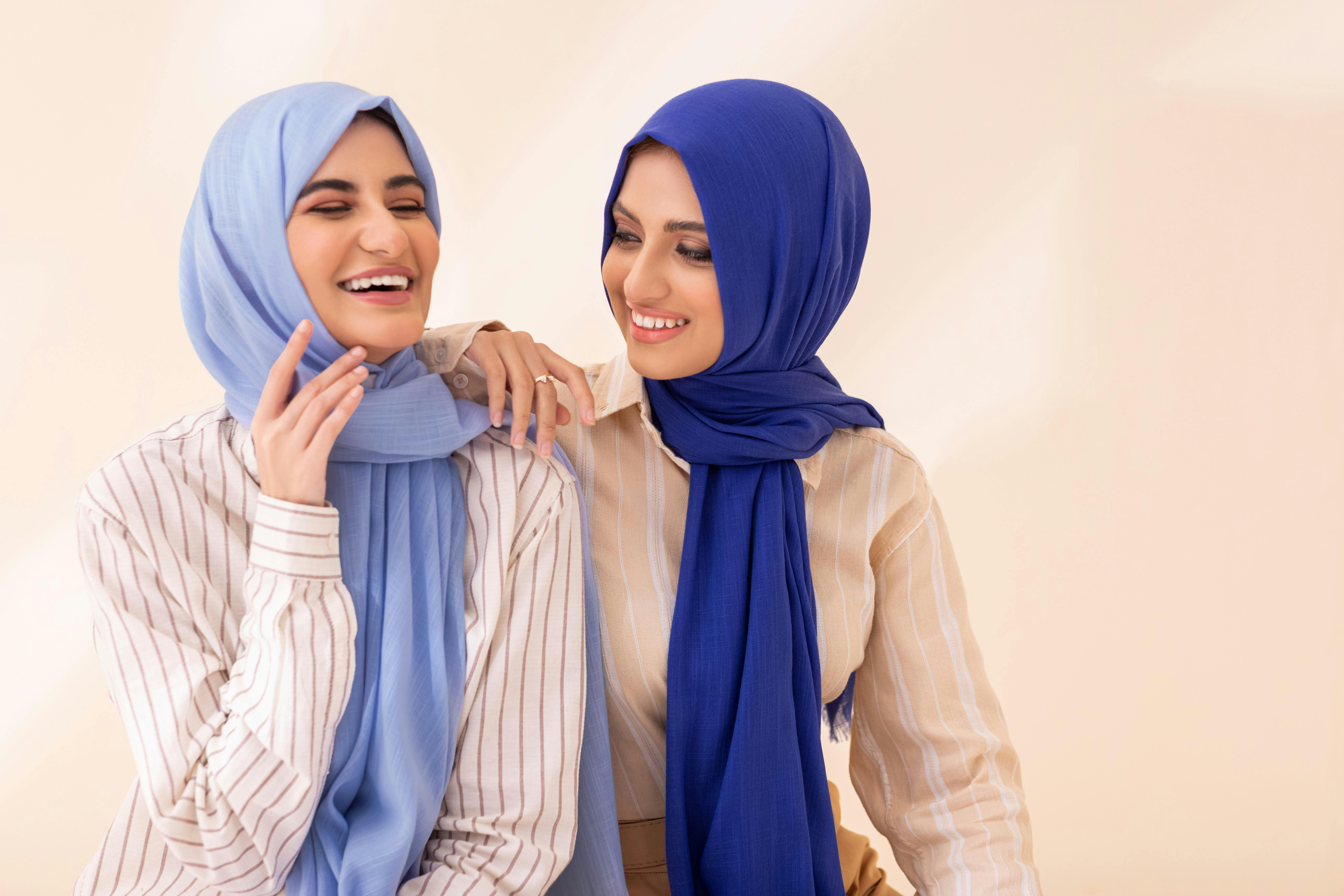 Two Smiling Women in Colorful Hijabs on Neutral Background · Free Stock ...