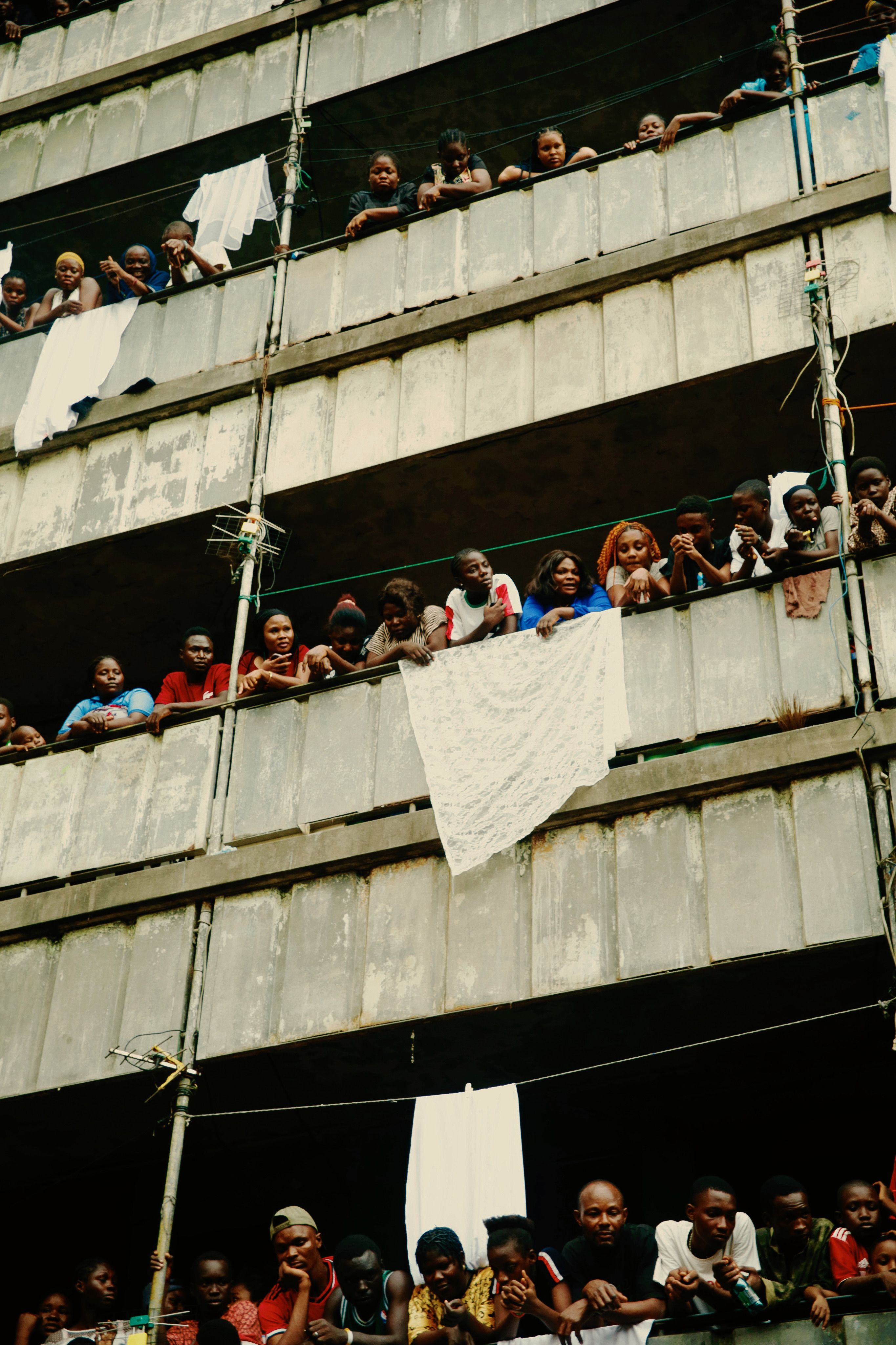 Urban Life: Crowds on Concrete Balconies · Free Stock Photo