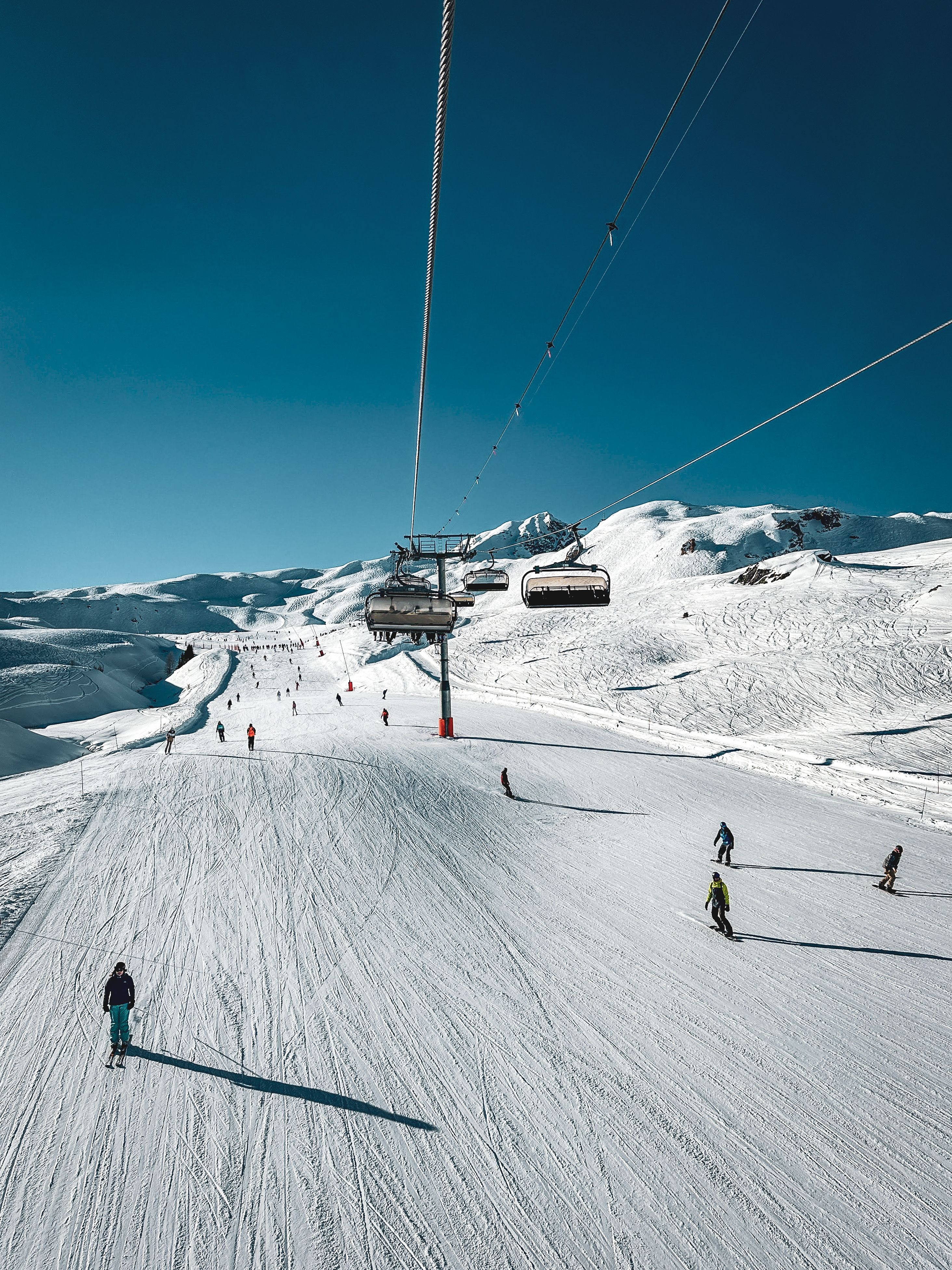 Skiers on the Slope with a Ski Lift · Free Stock Photo