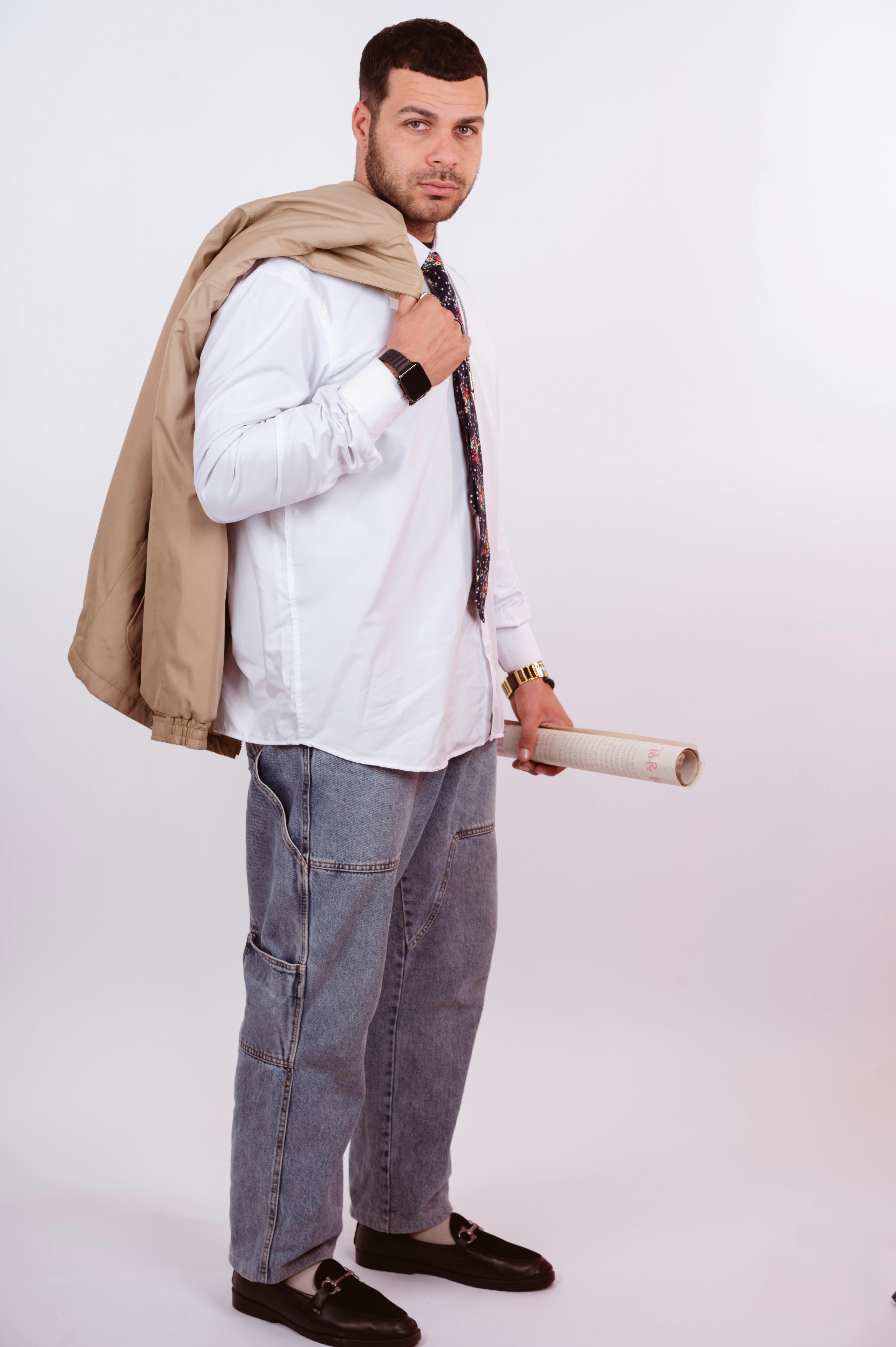 Confident Man Holding Architectural Plan · Free Stock Photo