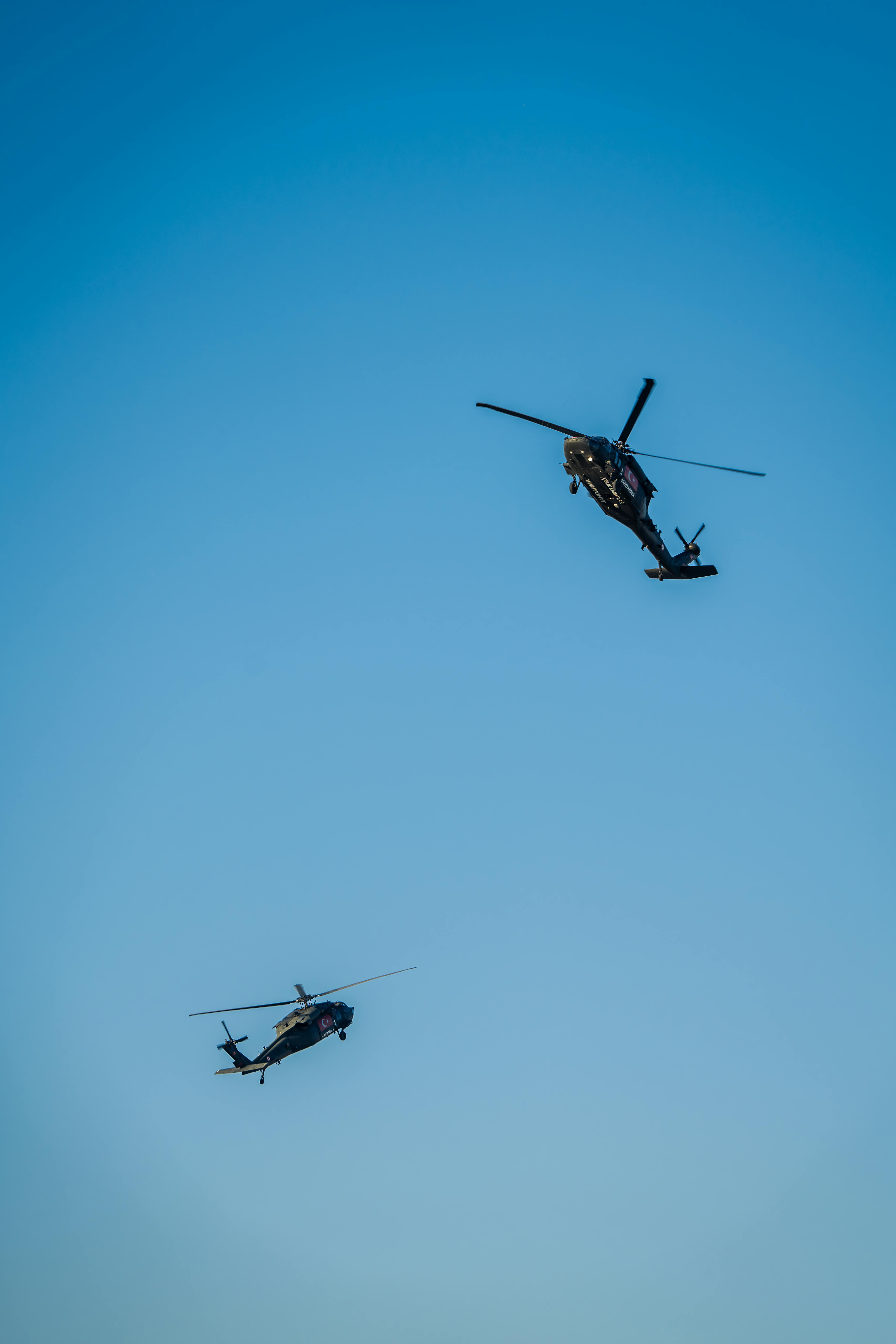 Two Military Helicopters Flying in Formation · Free Stock Photo