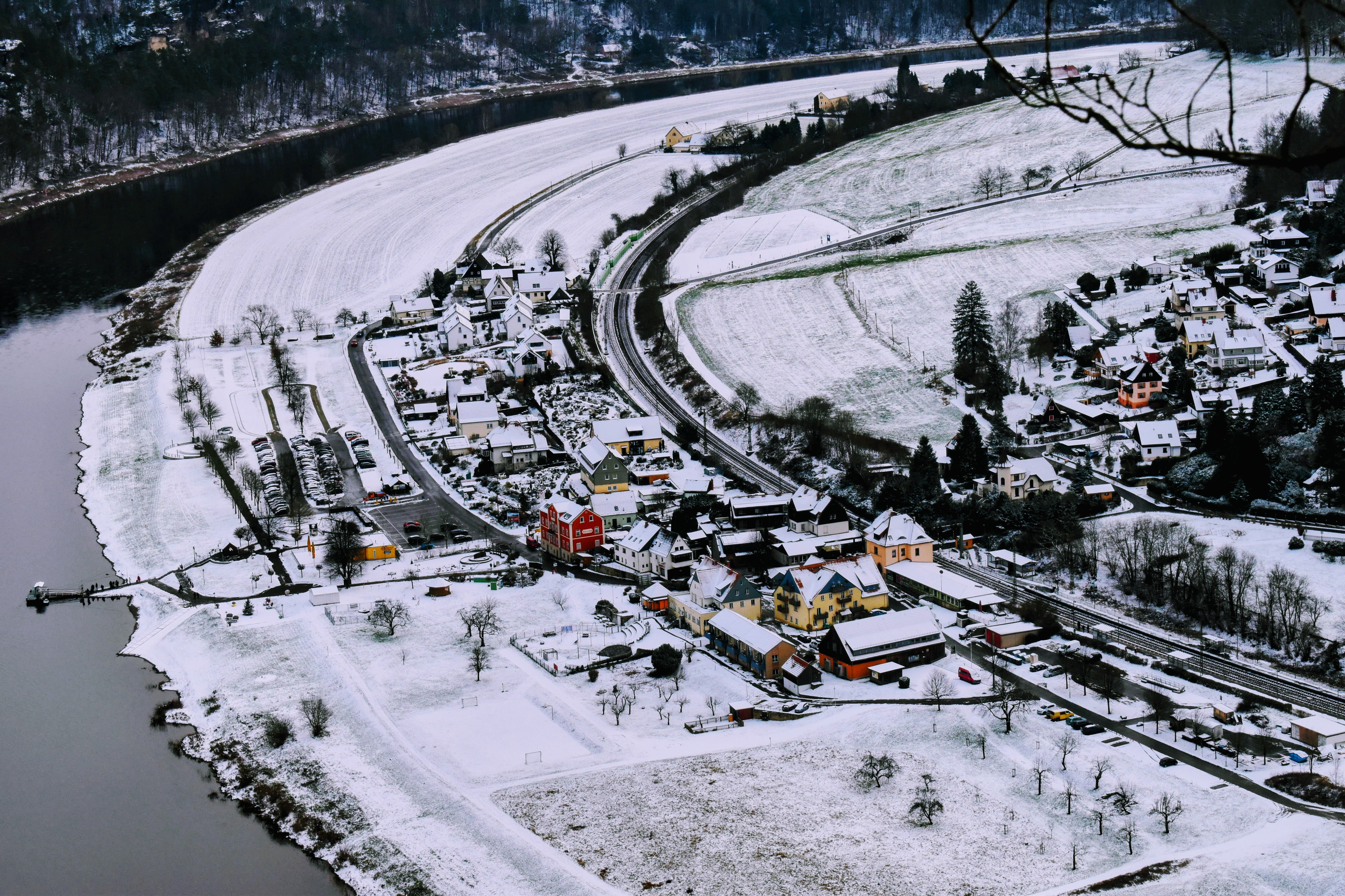 Scenic Snow-Covered Village by the Riverside · Free Stock Photo