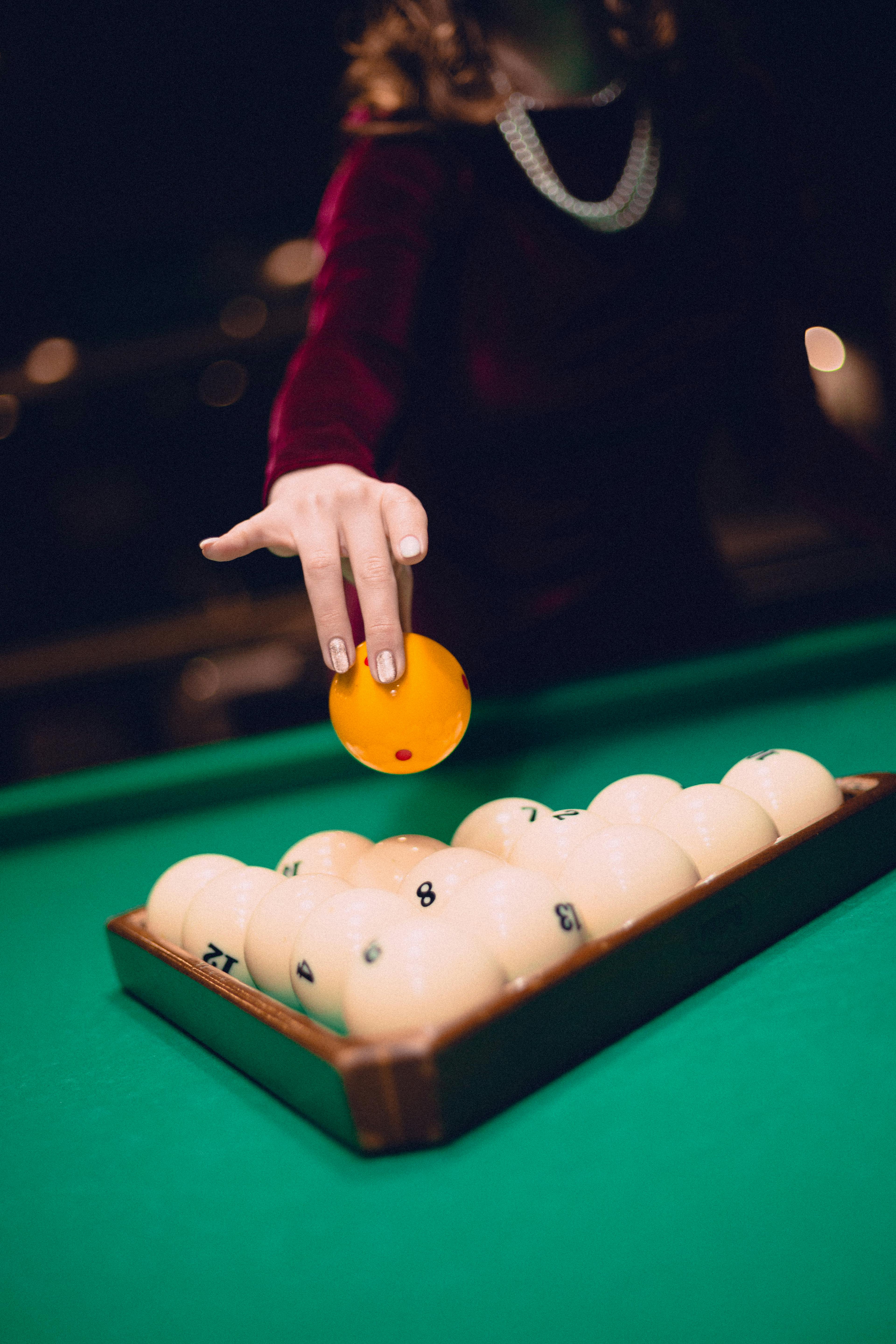 Woman Organizing Billiard Balls on Pool Table · Free Stock Photo