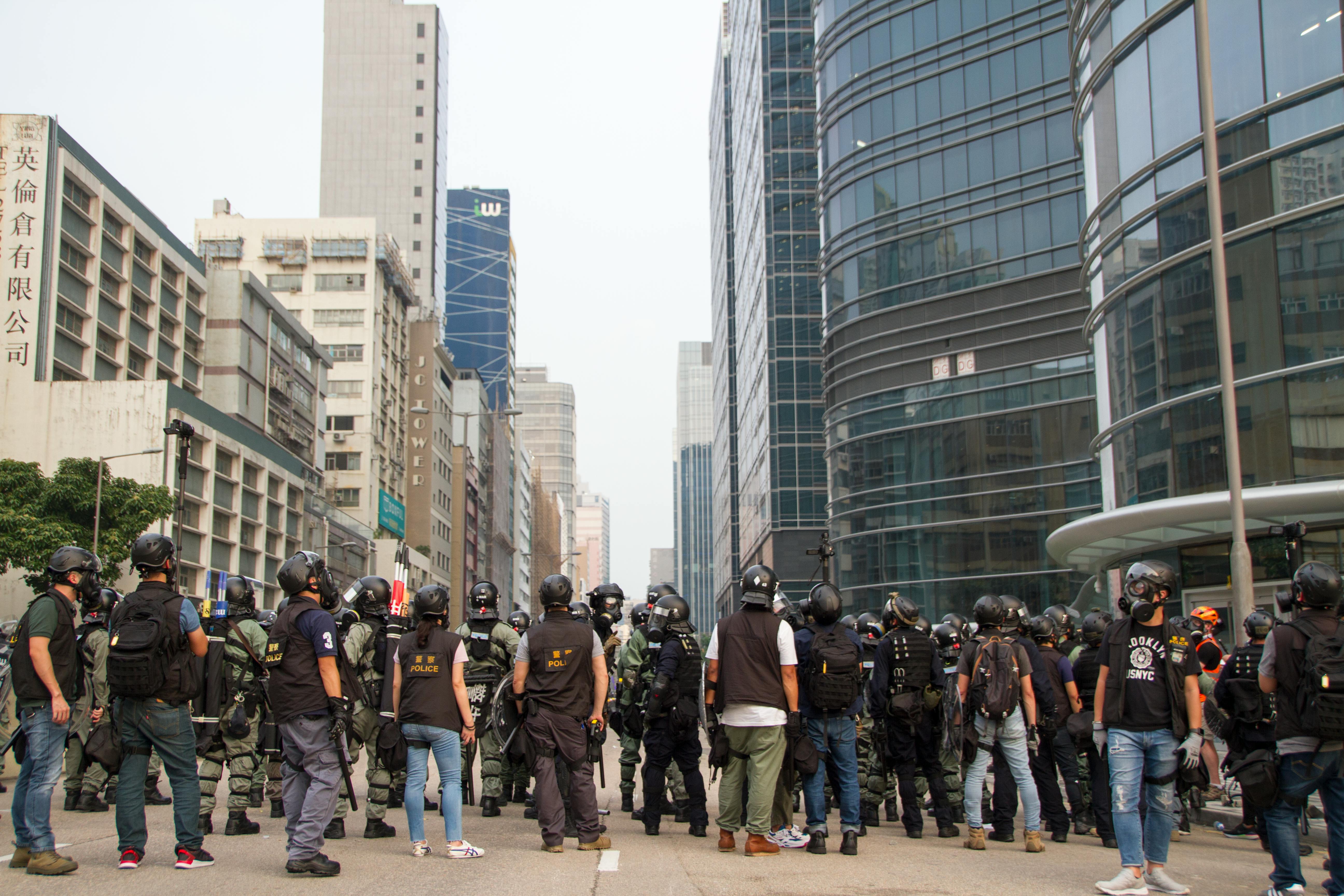 Law Enforcement Officers in Riot Gear Standing in the Middle of the ...