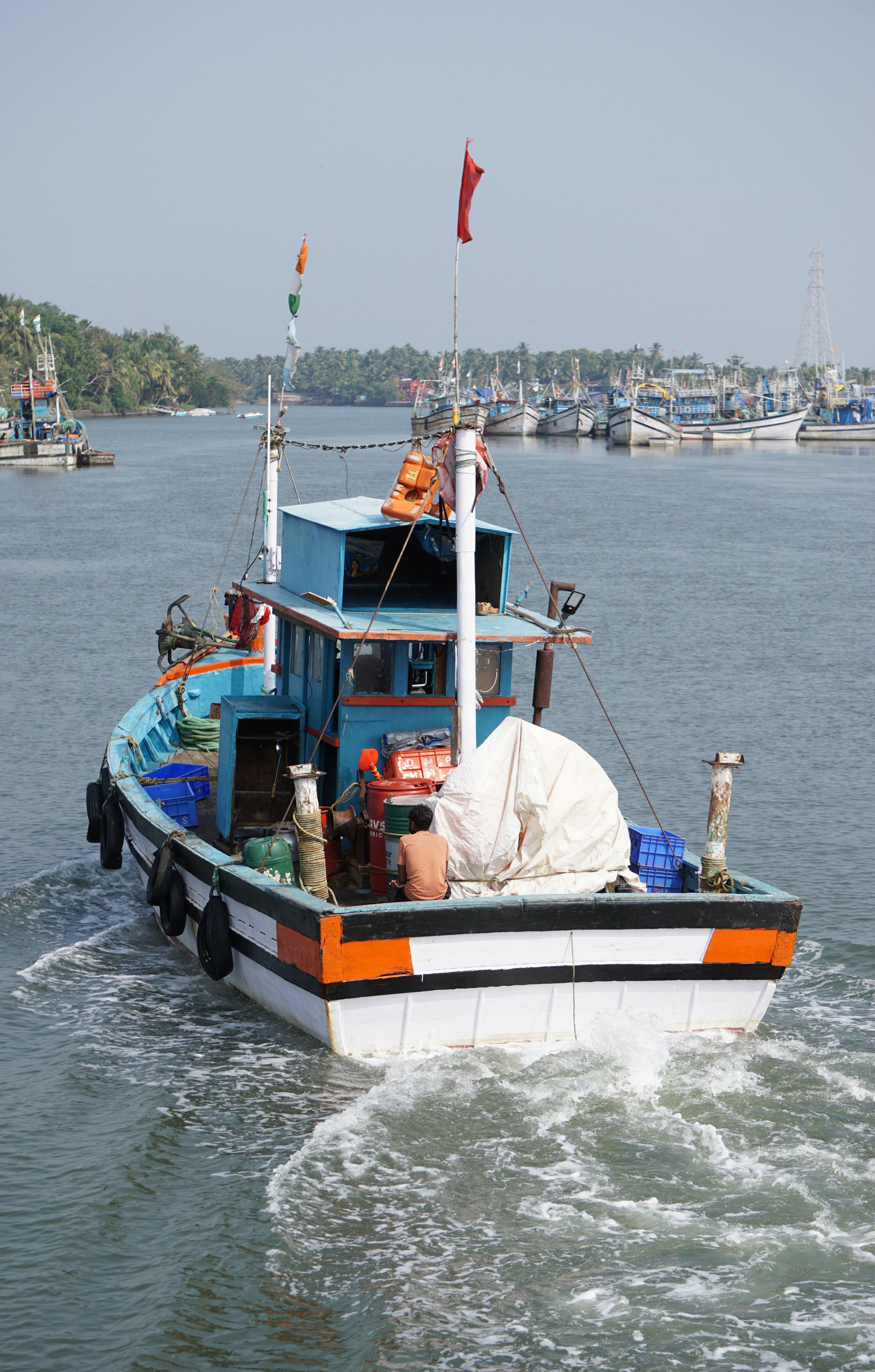 Fishing Boat Navigating Goan Waters on a Sunny Day · Free Stock Photo