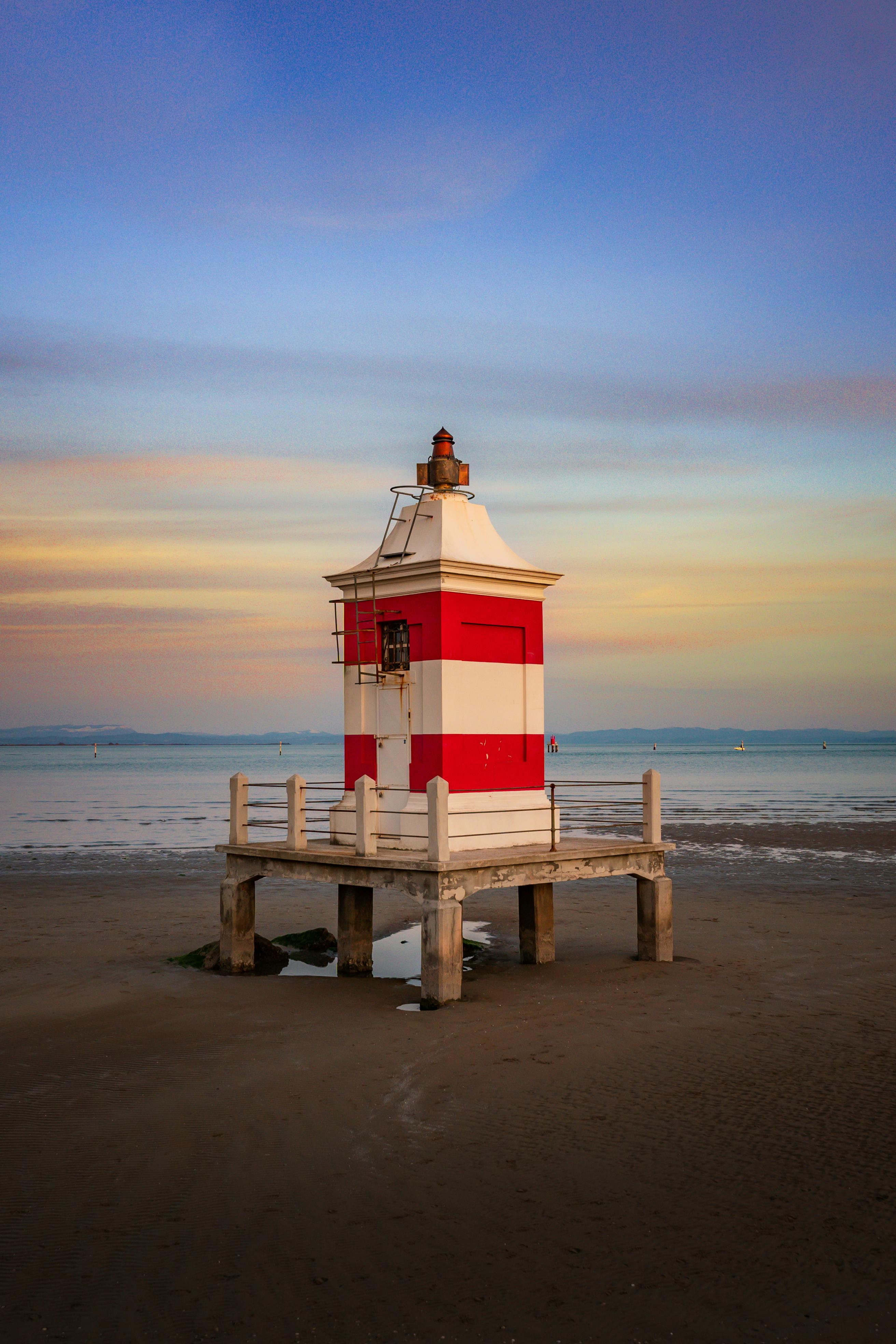 Red and White Seaside Lighthouse at Sunrise · Free Stock Photo