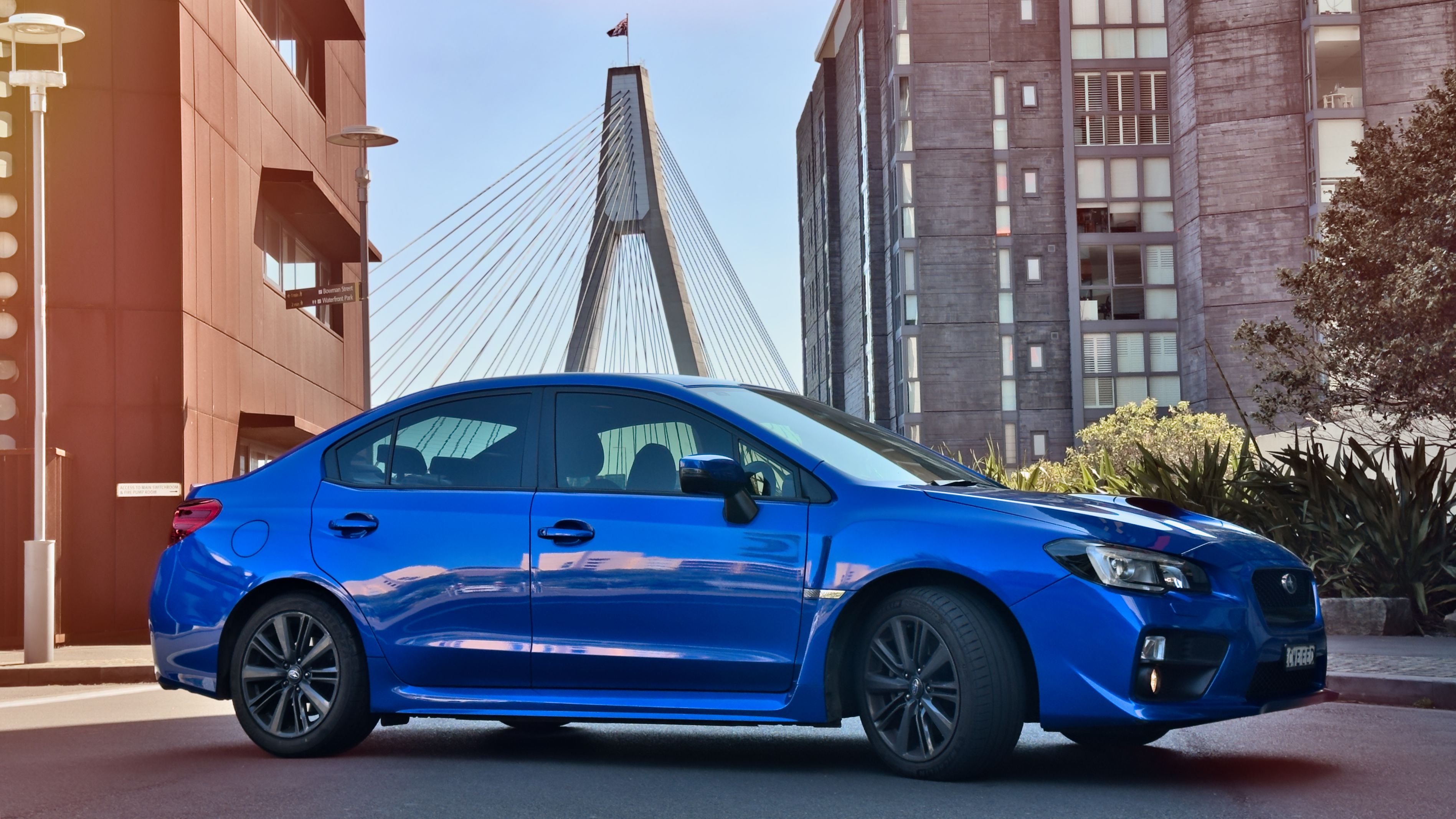 Blue Subaru WRX in Pyrmont with Anzac Bridge · Free Stock Photo