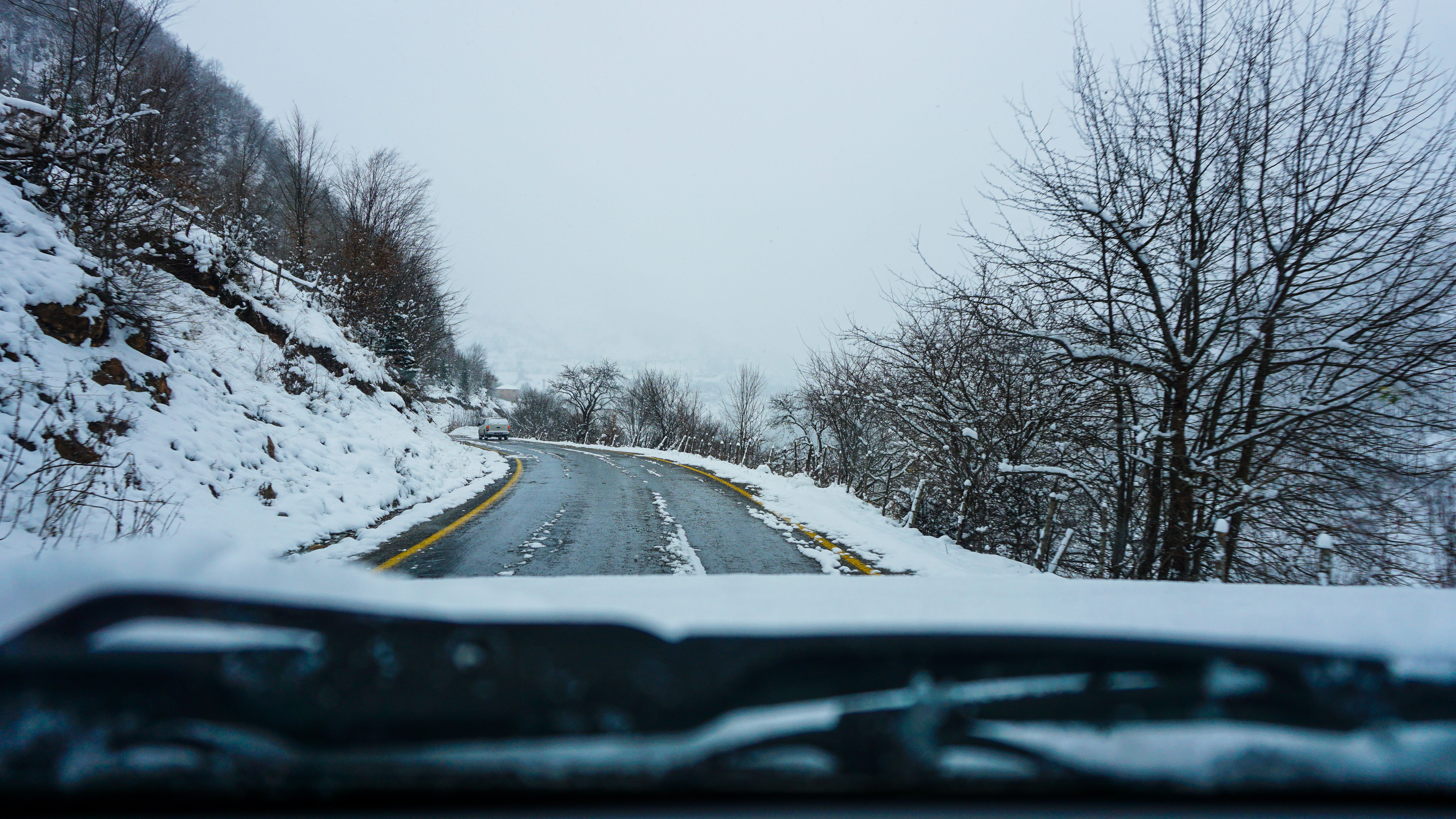 Scenic Winter Road Through Snow-Covered Landscape · Free Stock Photo