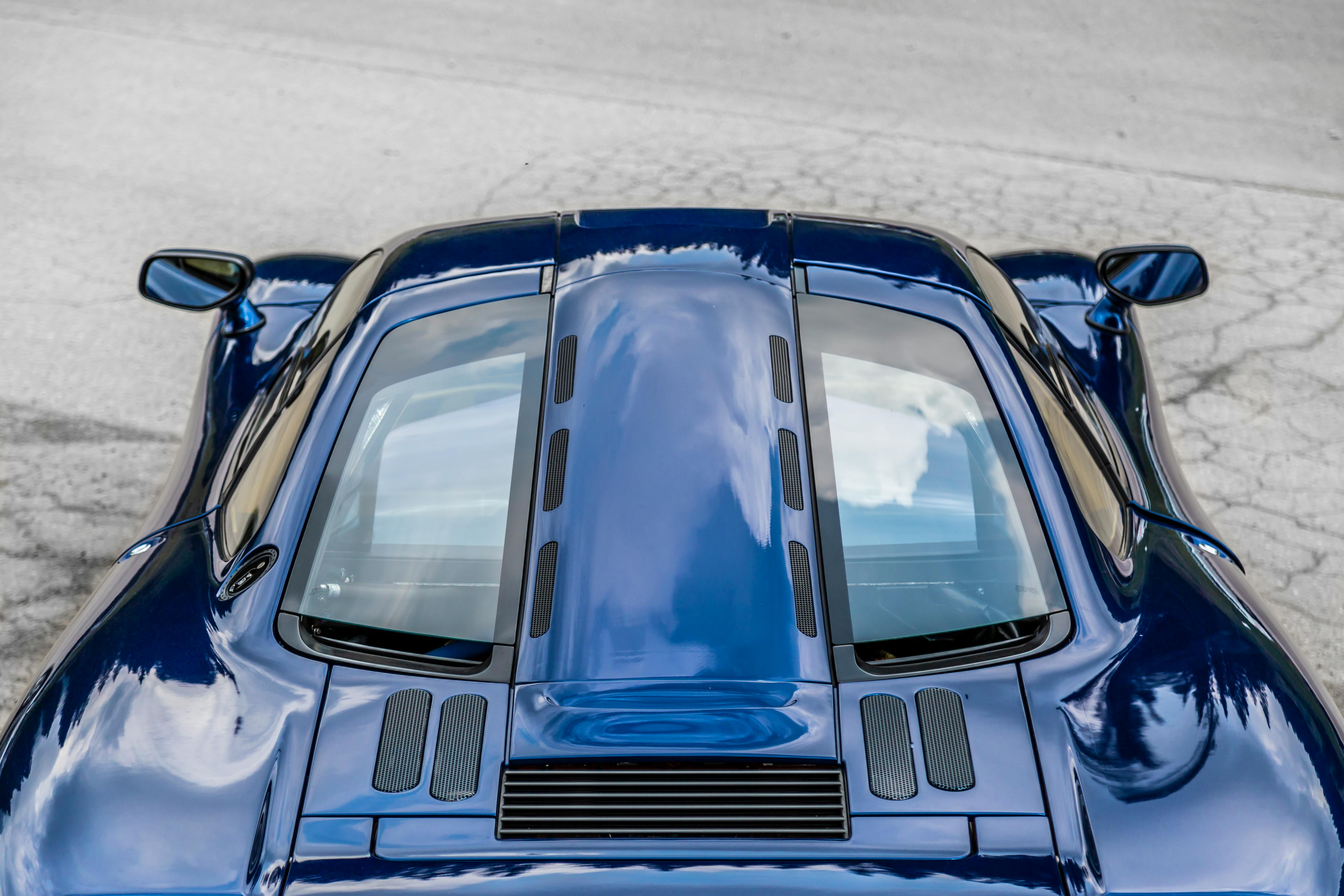 Top View of a Sleek Blue Supercar with Striking Design · Free Stock Photo