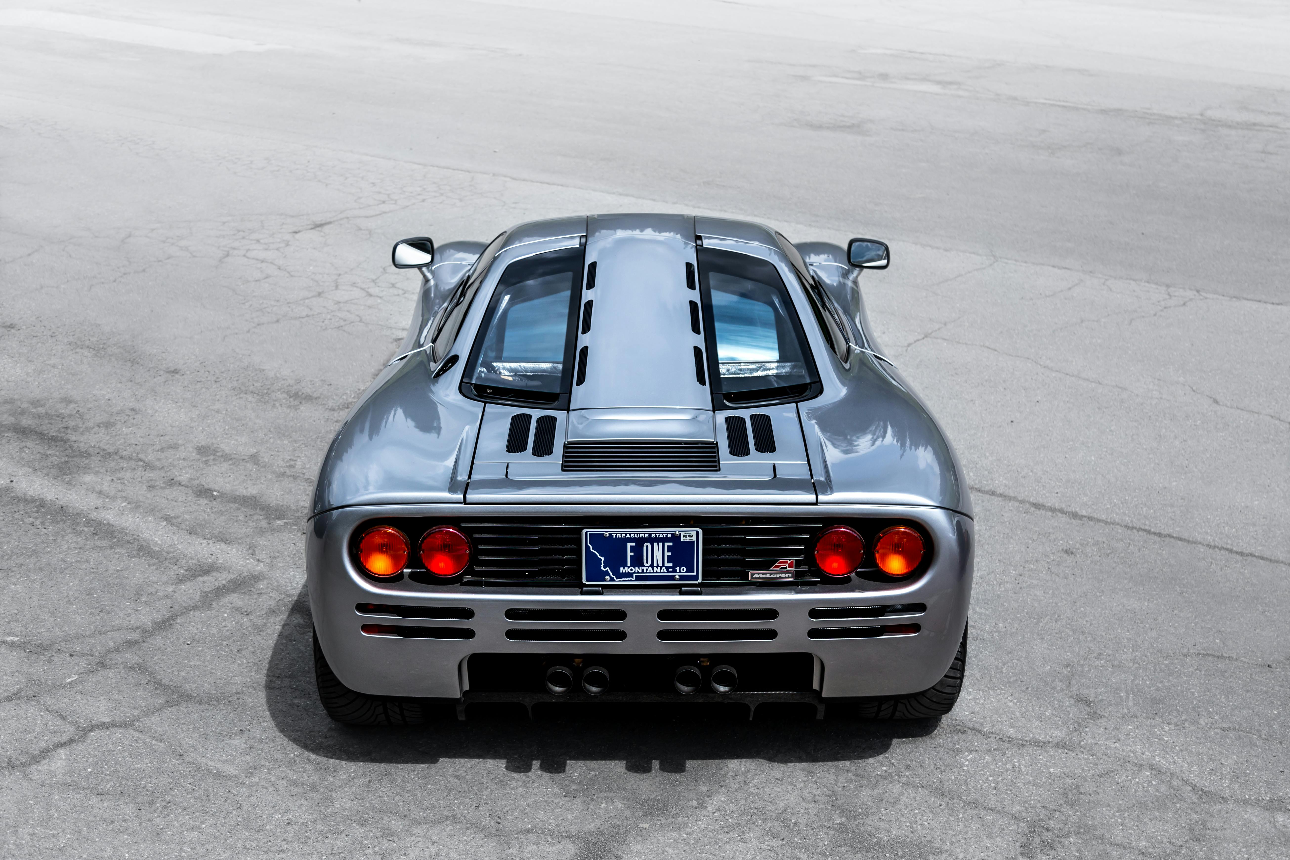 McLaren Supercar Rear View on Open Road · Free Stock Photo