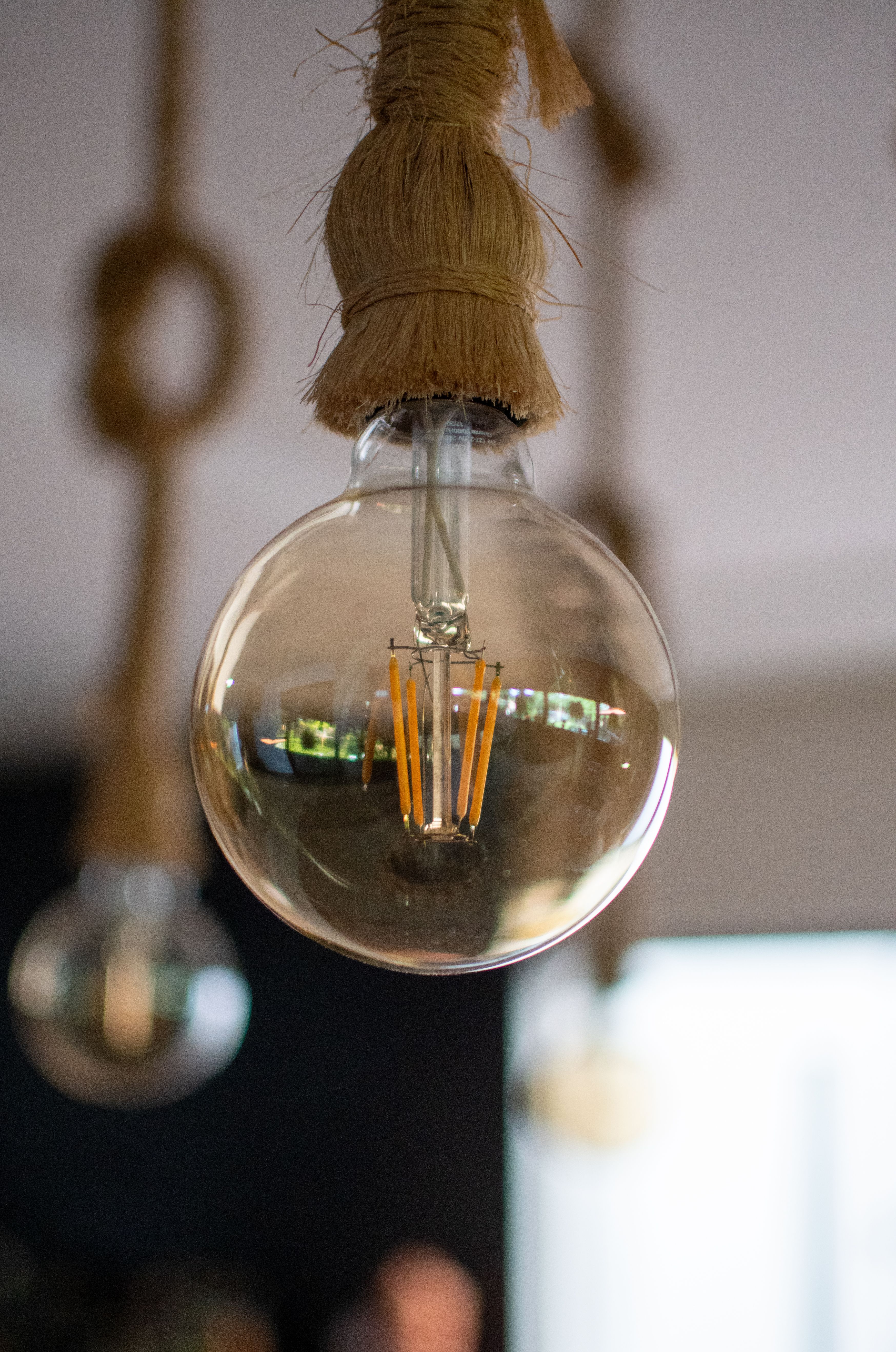 Vintage Edison Bulb with Rope Hanging Indoors · Free Stock Photo