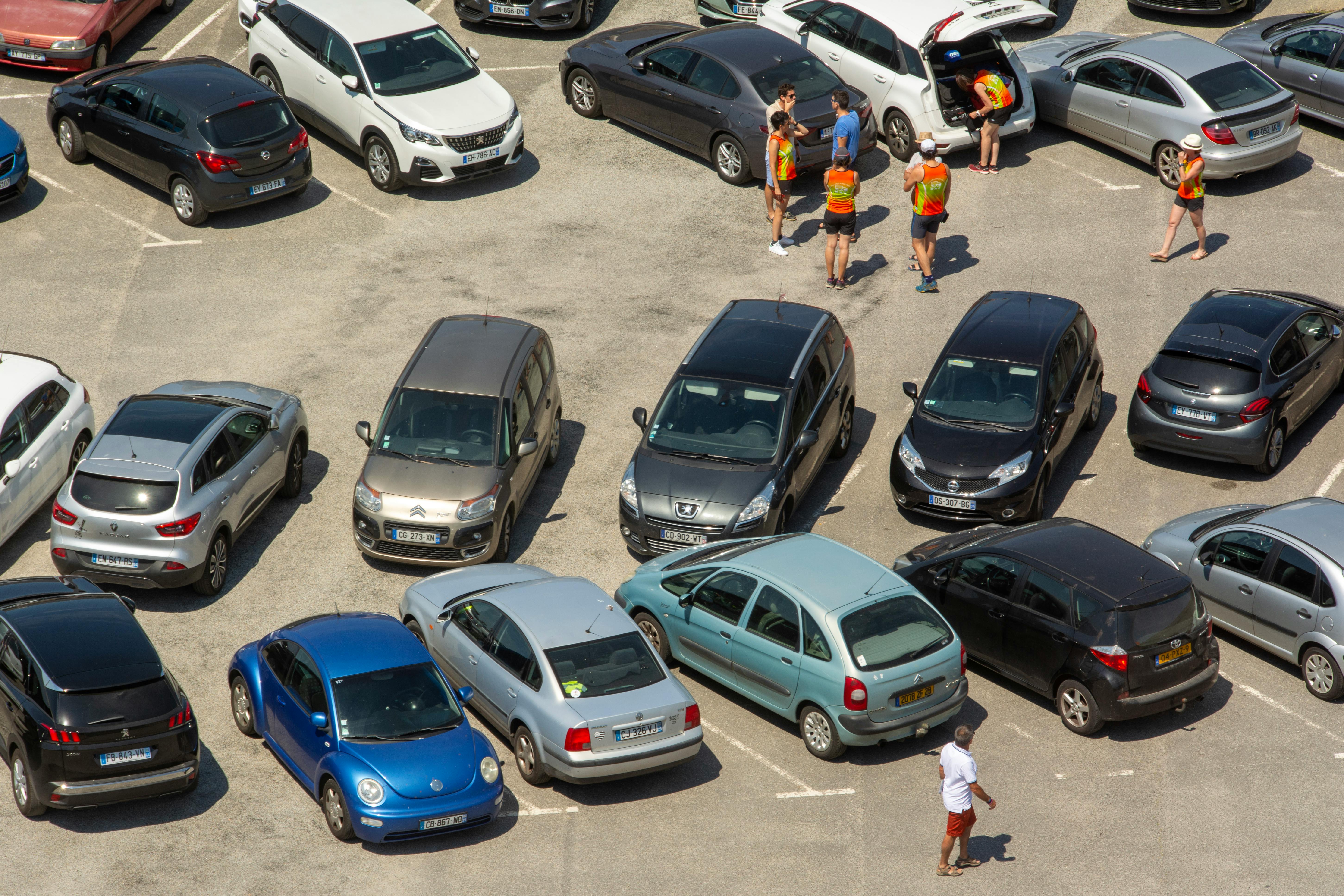 Aerial View of Busy Parking Lot with Cars and People · Free Stock Photo