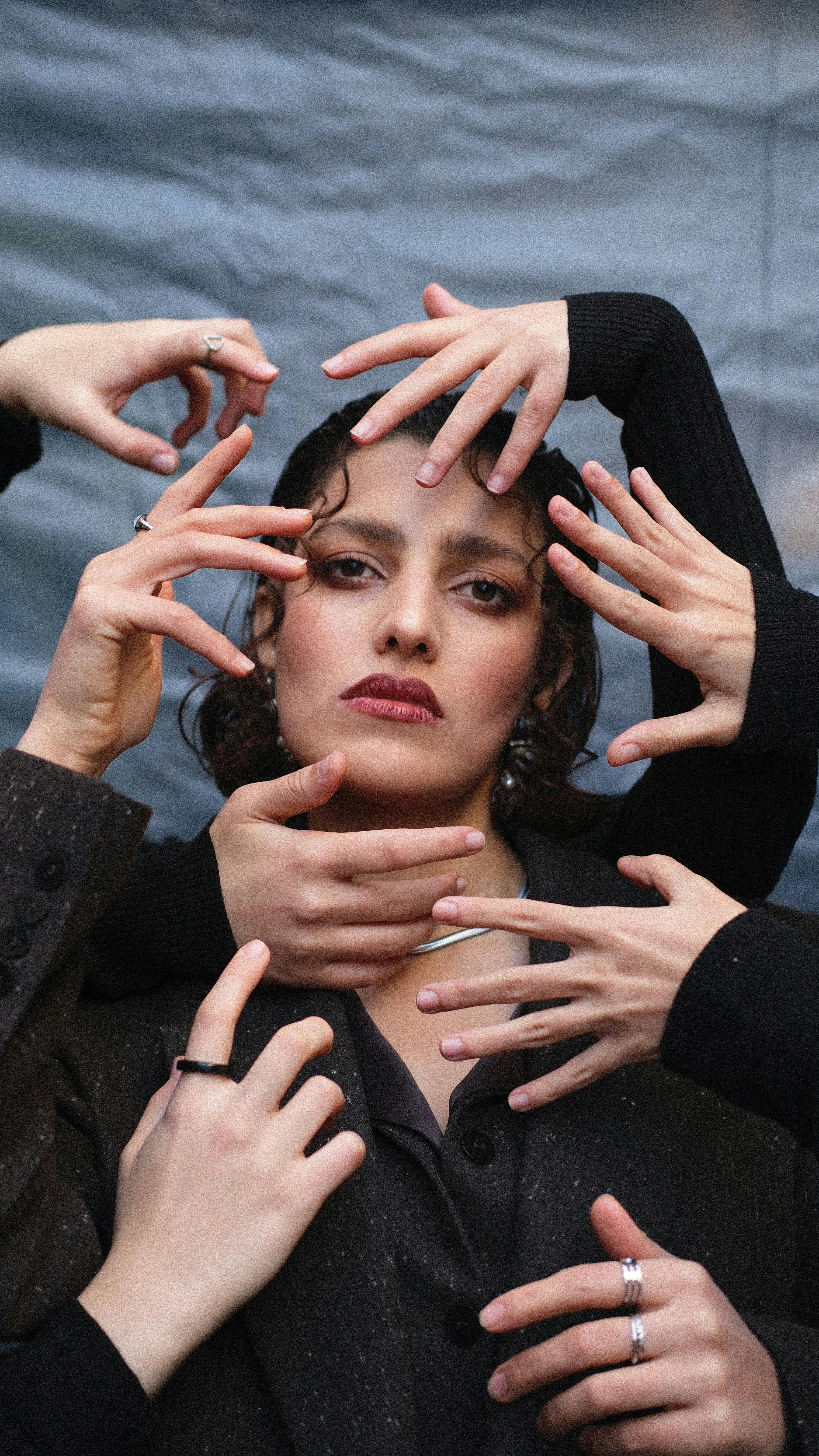 Creative Portrait with Multiple Hands in Frame · Free Stock Photo