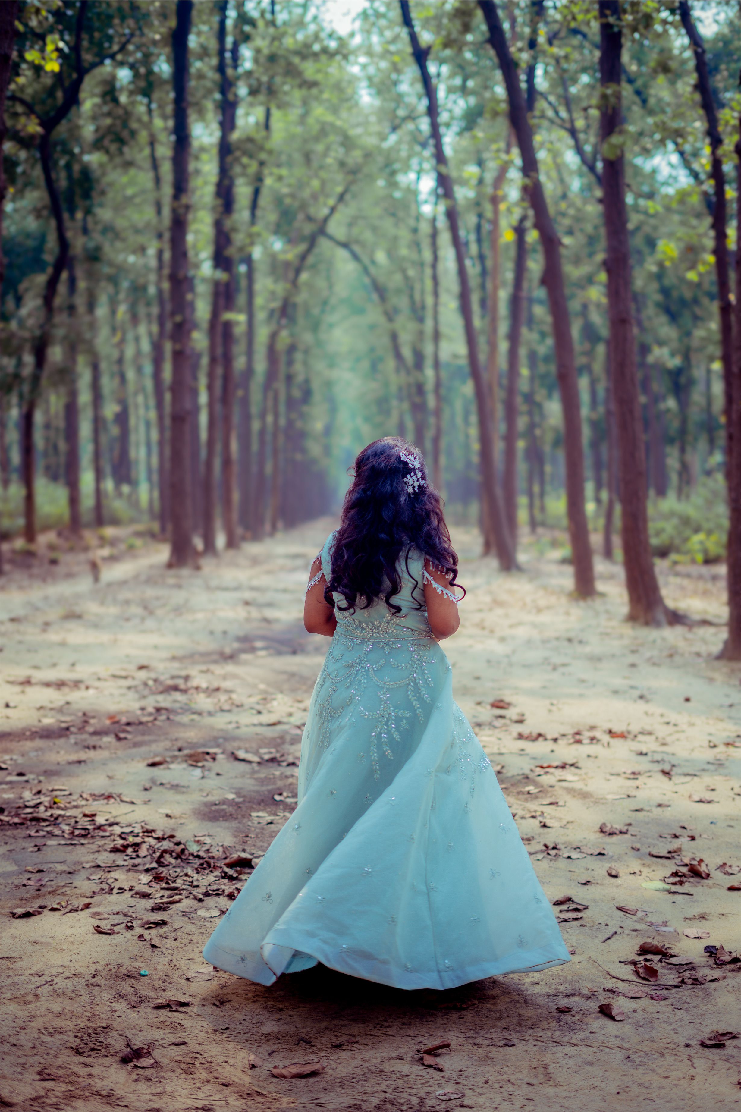 Bride in Blue Dress Walking Through Forest Path · Free Stock Photo