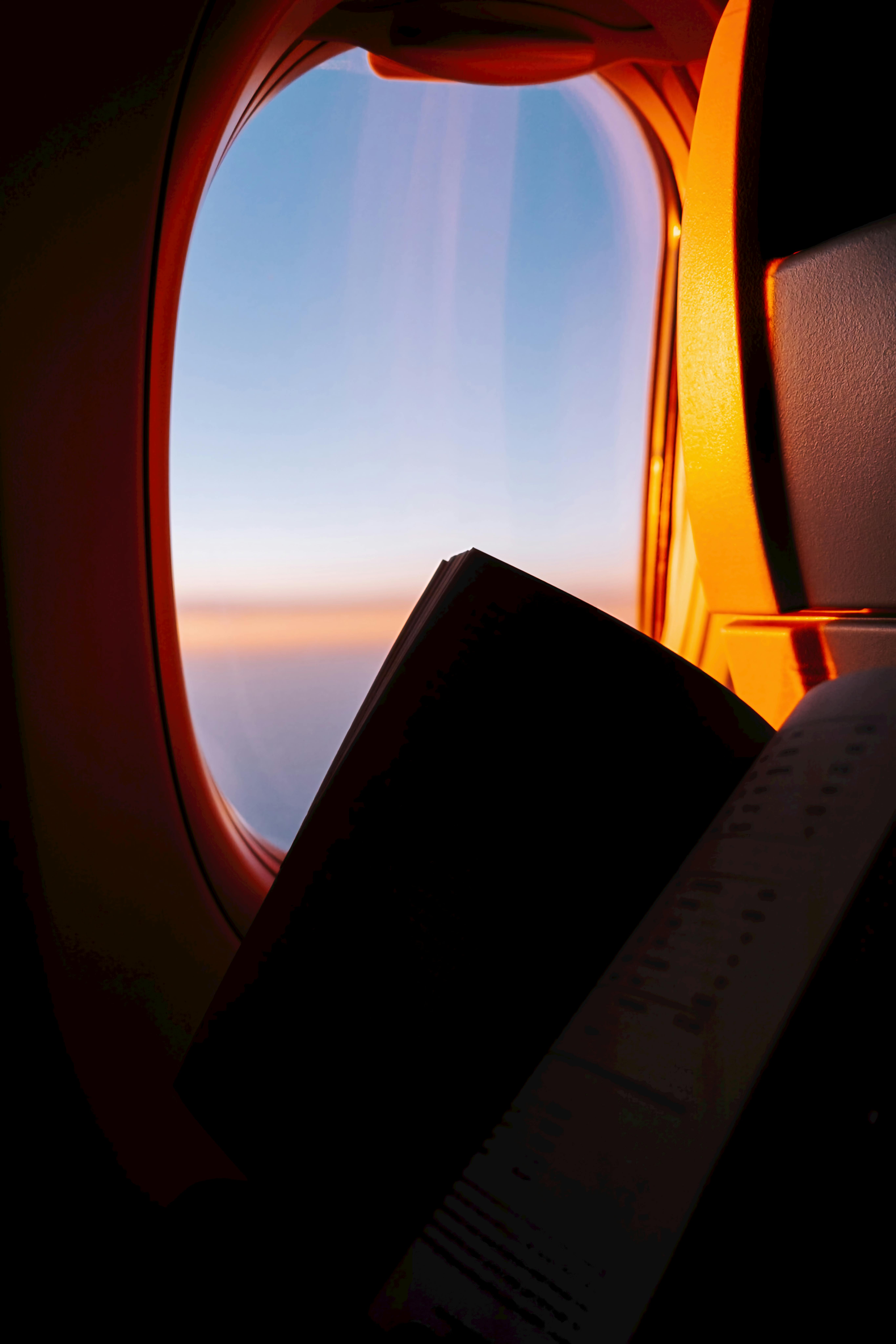 Tranquil In-flight Reading at Sunset · Free Stock Photo