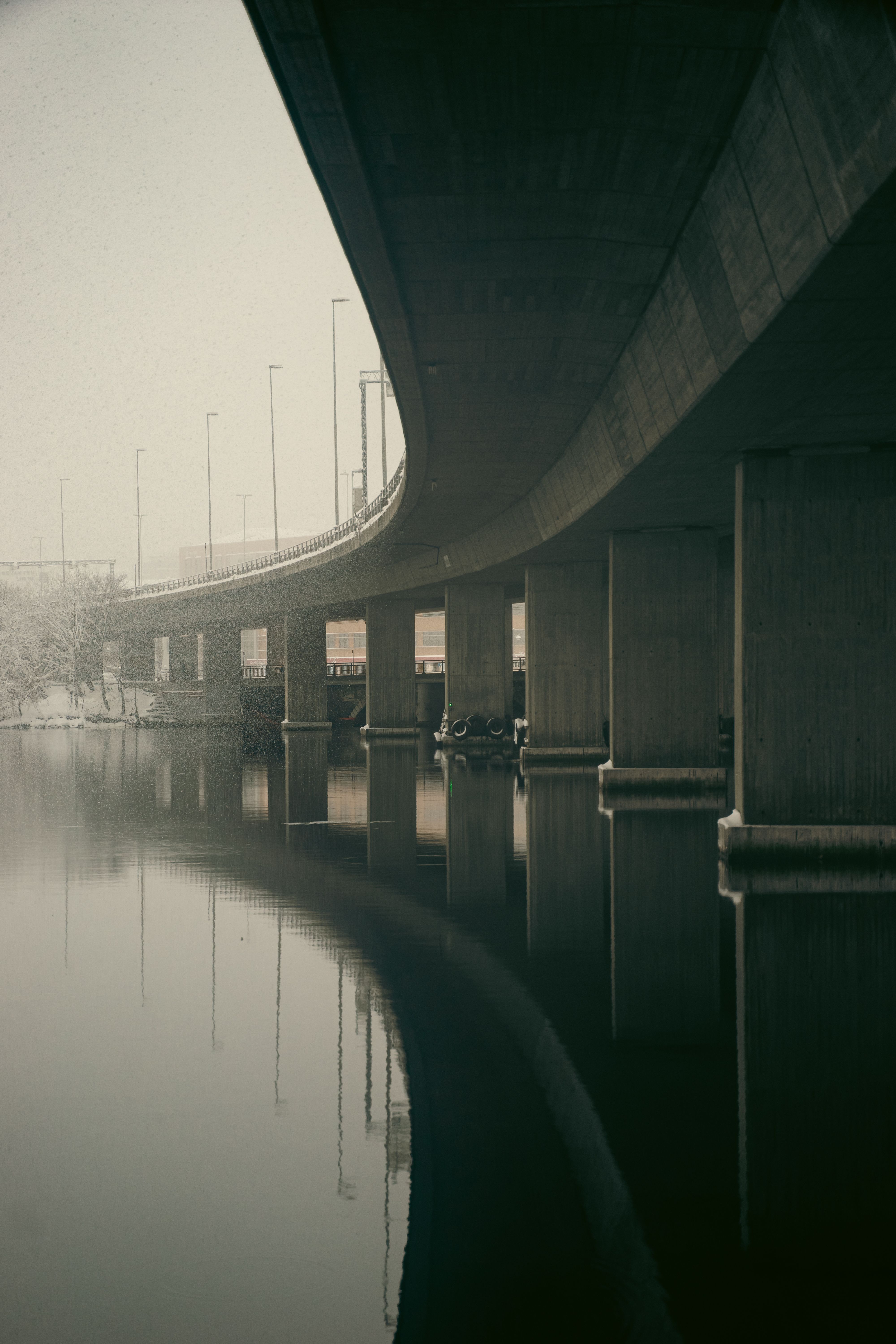 Urban Bridge Over Calm Water in Misty Setting · Free Stock Photo