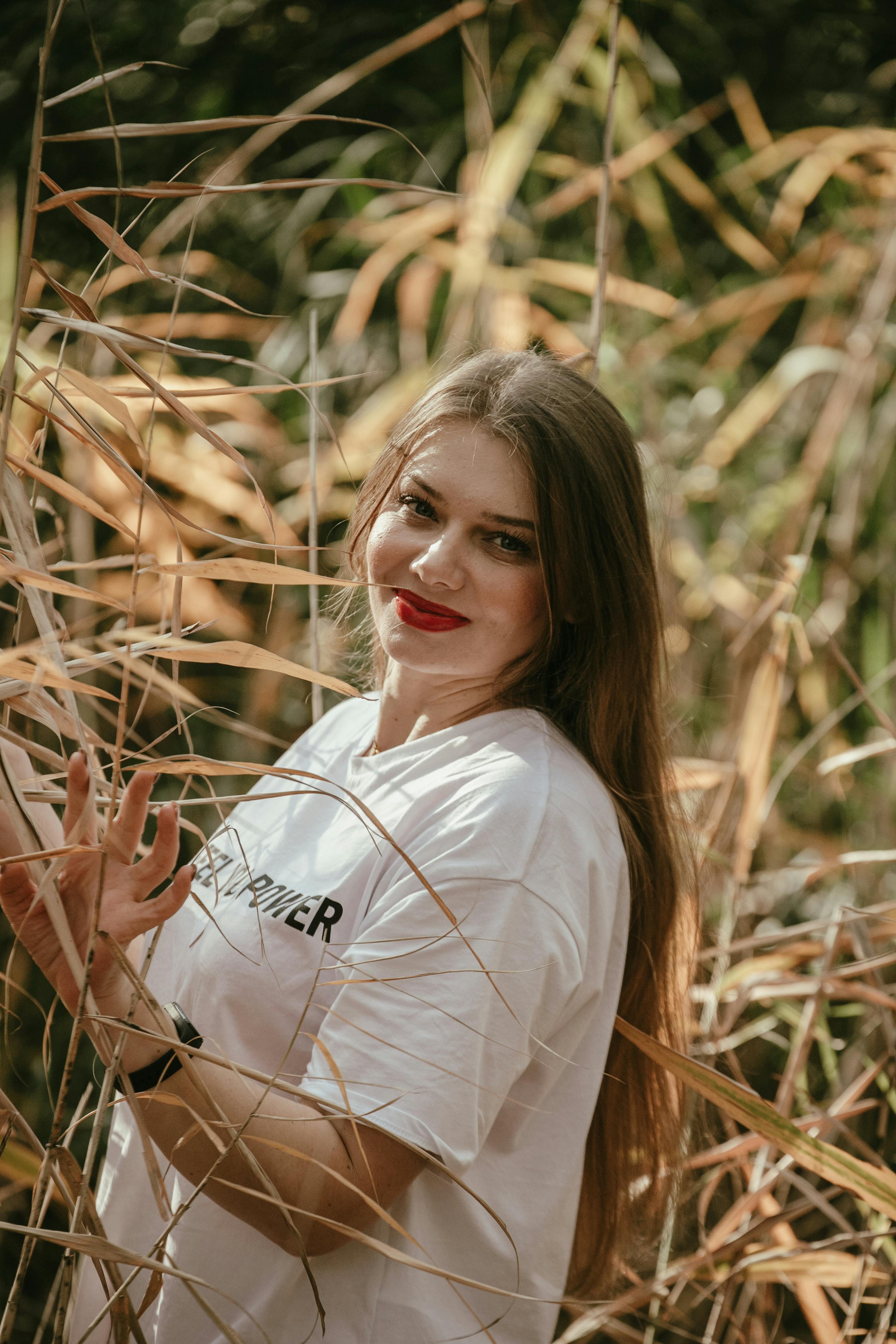 Woman in nature wearing "Empower" shirt outdoors · Free Stock Photo