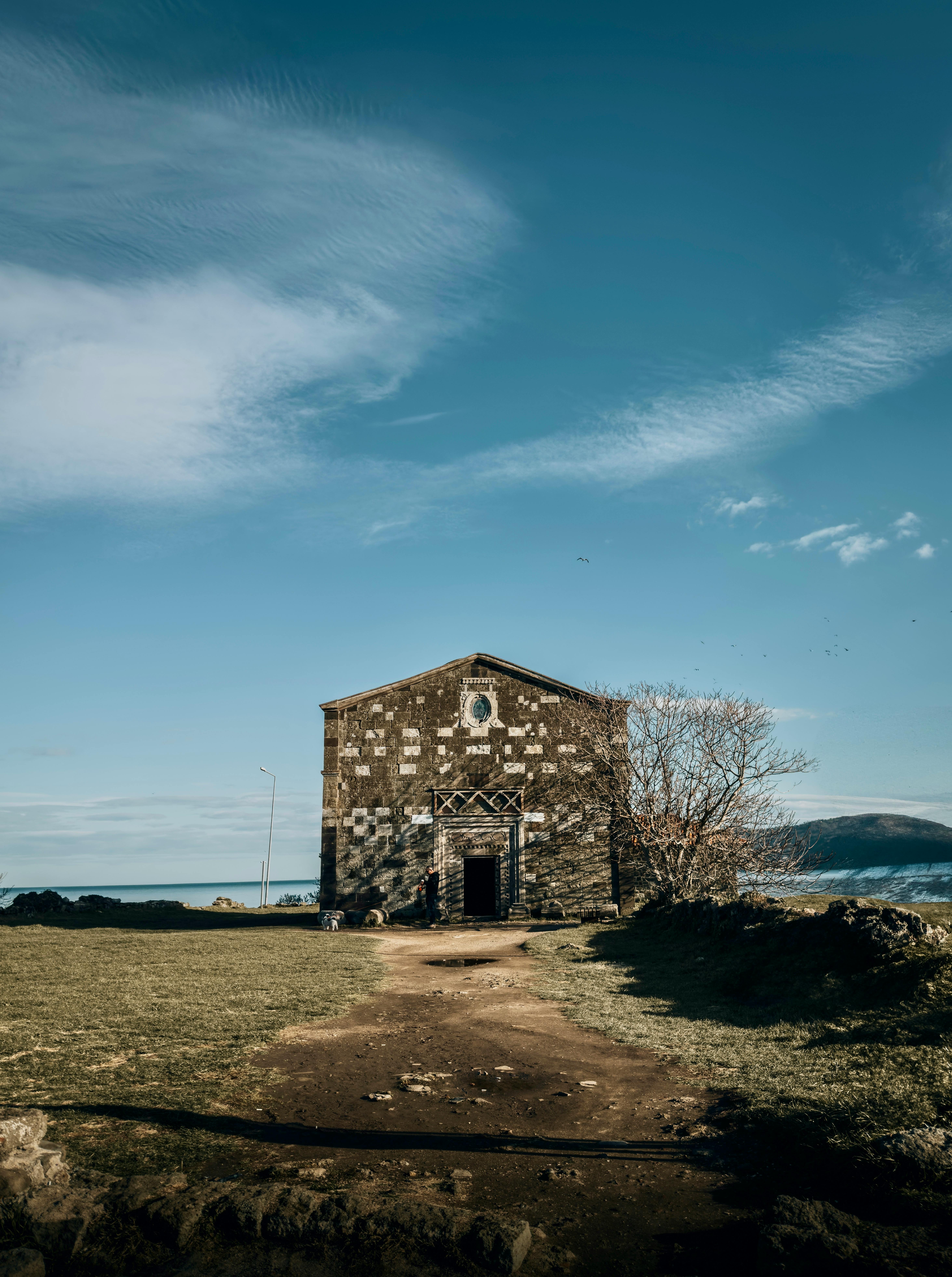 Historic Stone Church with Scenic Landscape · Free Stock Photo