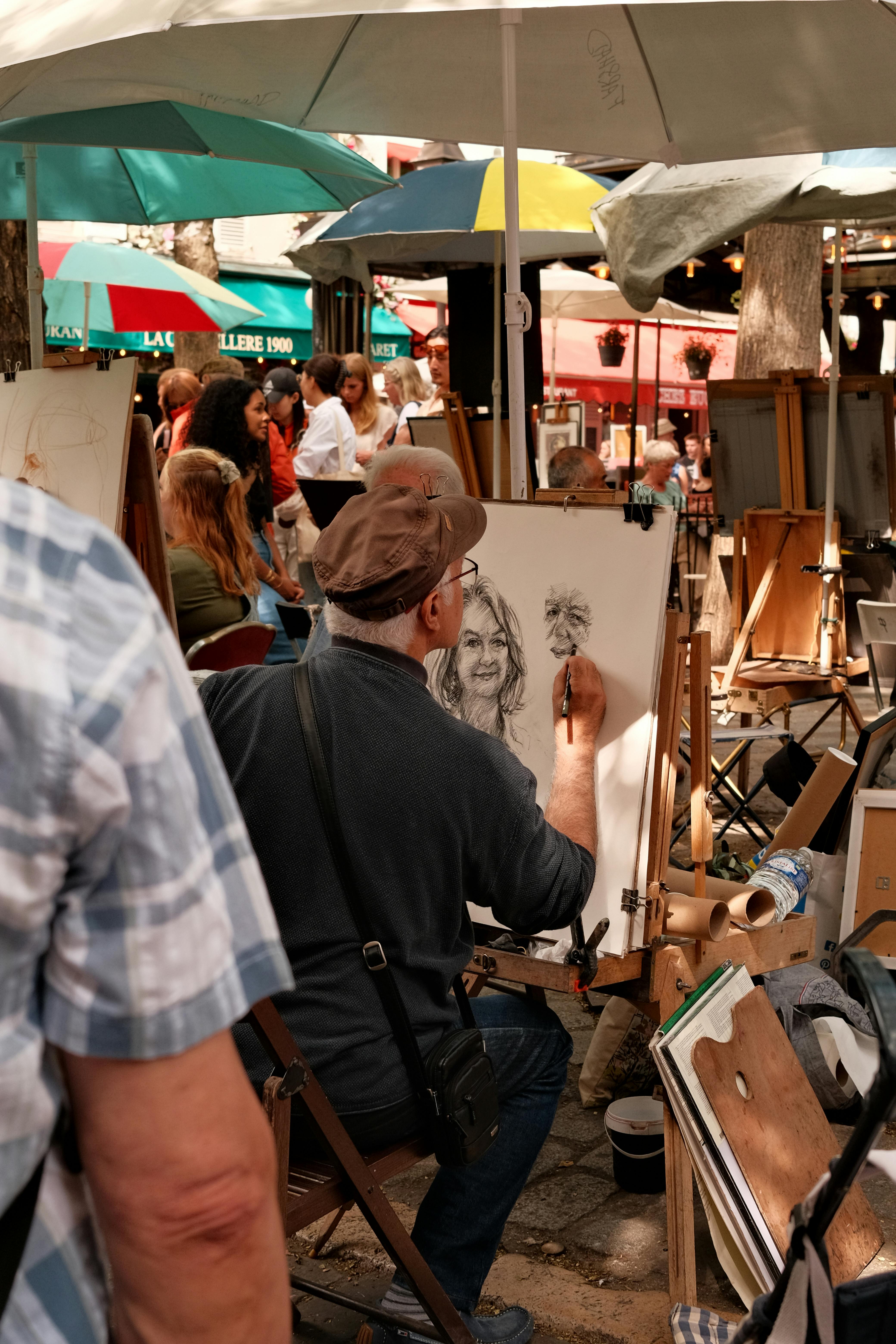 Street Artist Drawing Portrait in Vibrant Outdoor Setting · Free Stock ...