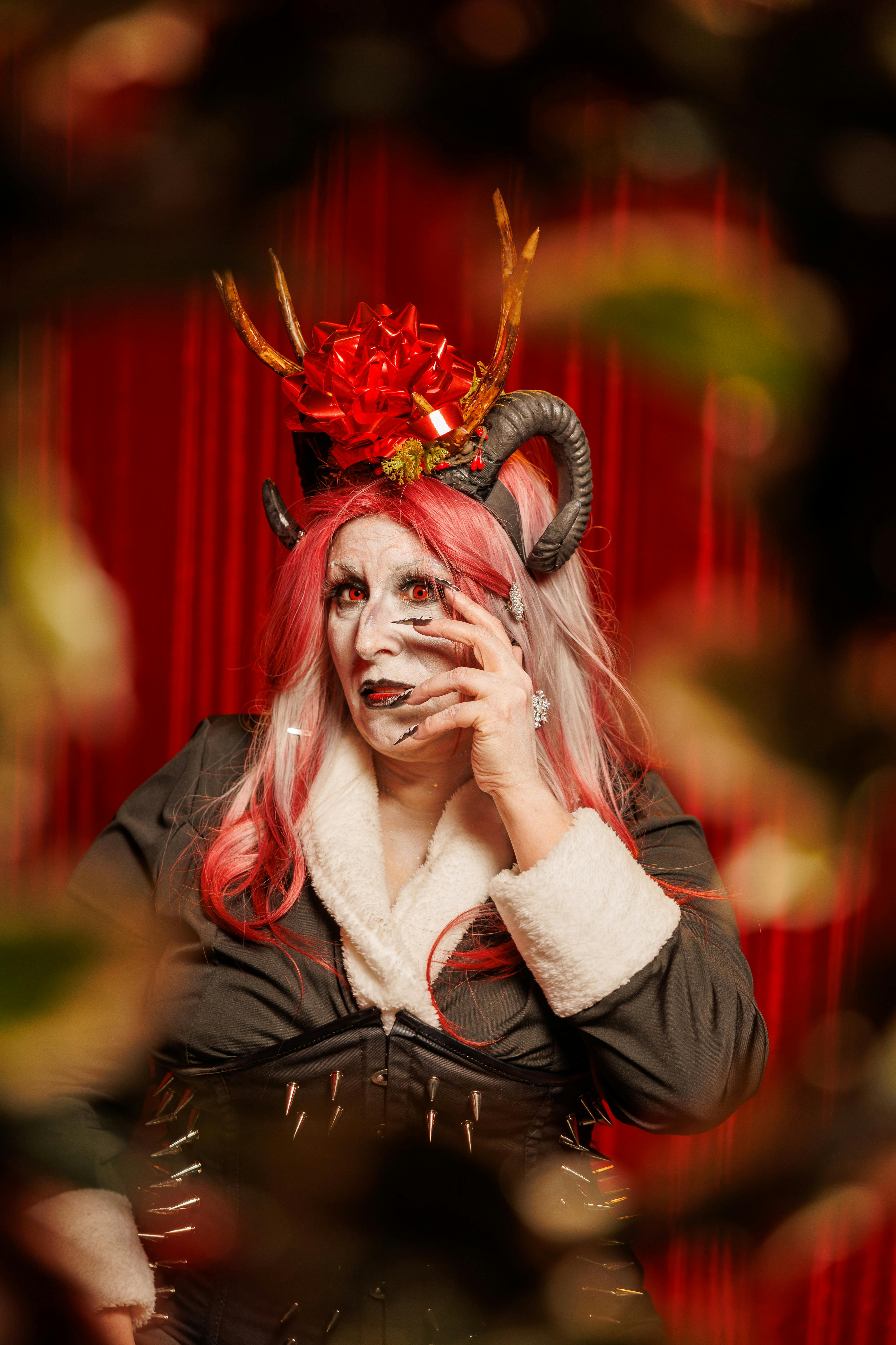 Festive Costume with Horns and Red Background · Free Stock Photo