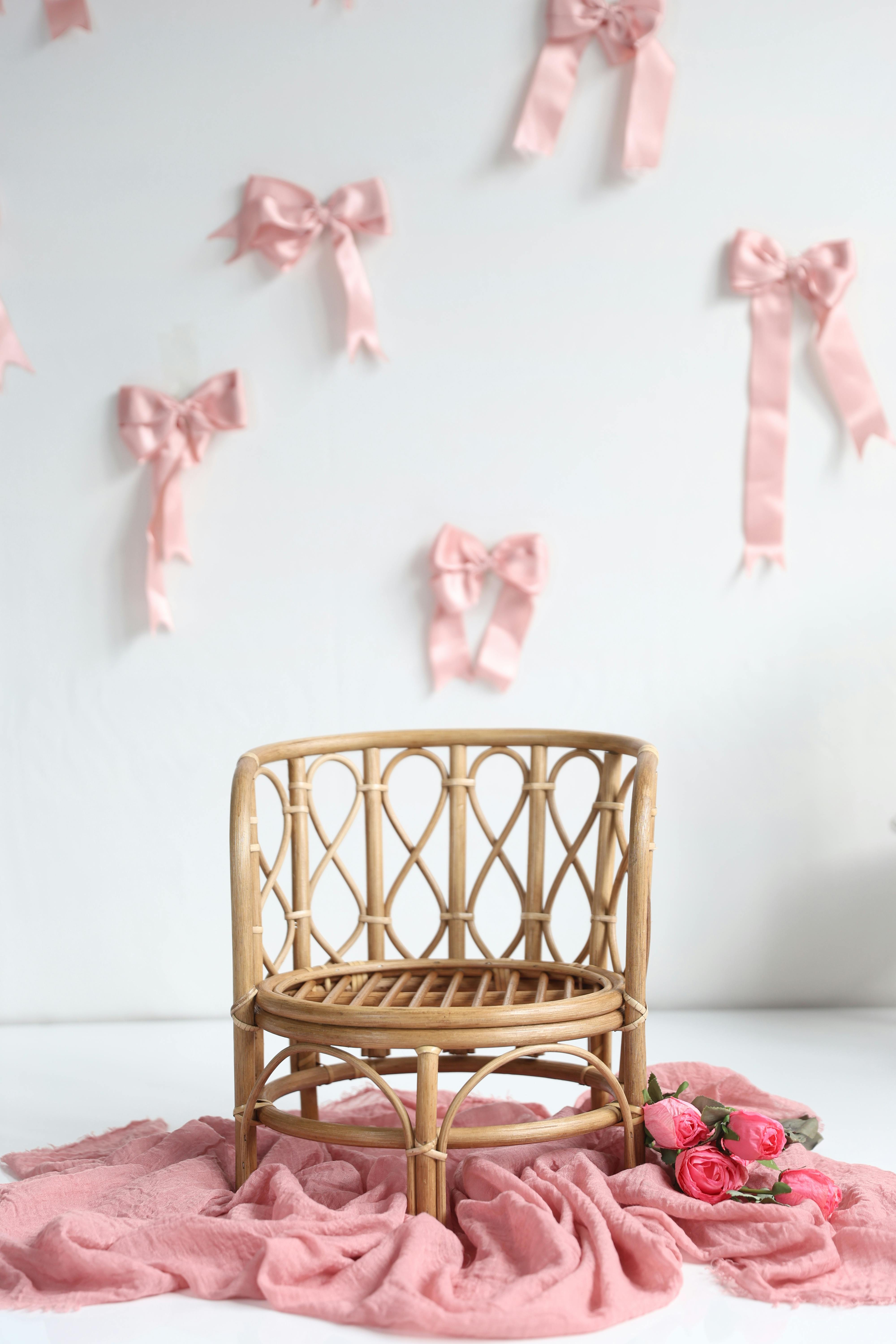 Charming Rattan Chair with Pink Decor Setup · Free Stock Photo