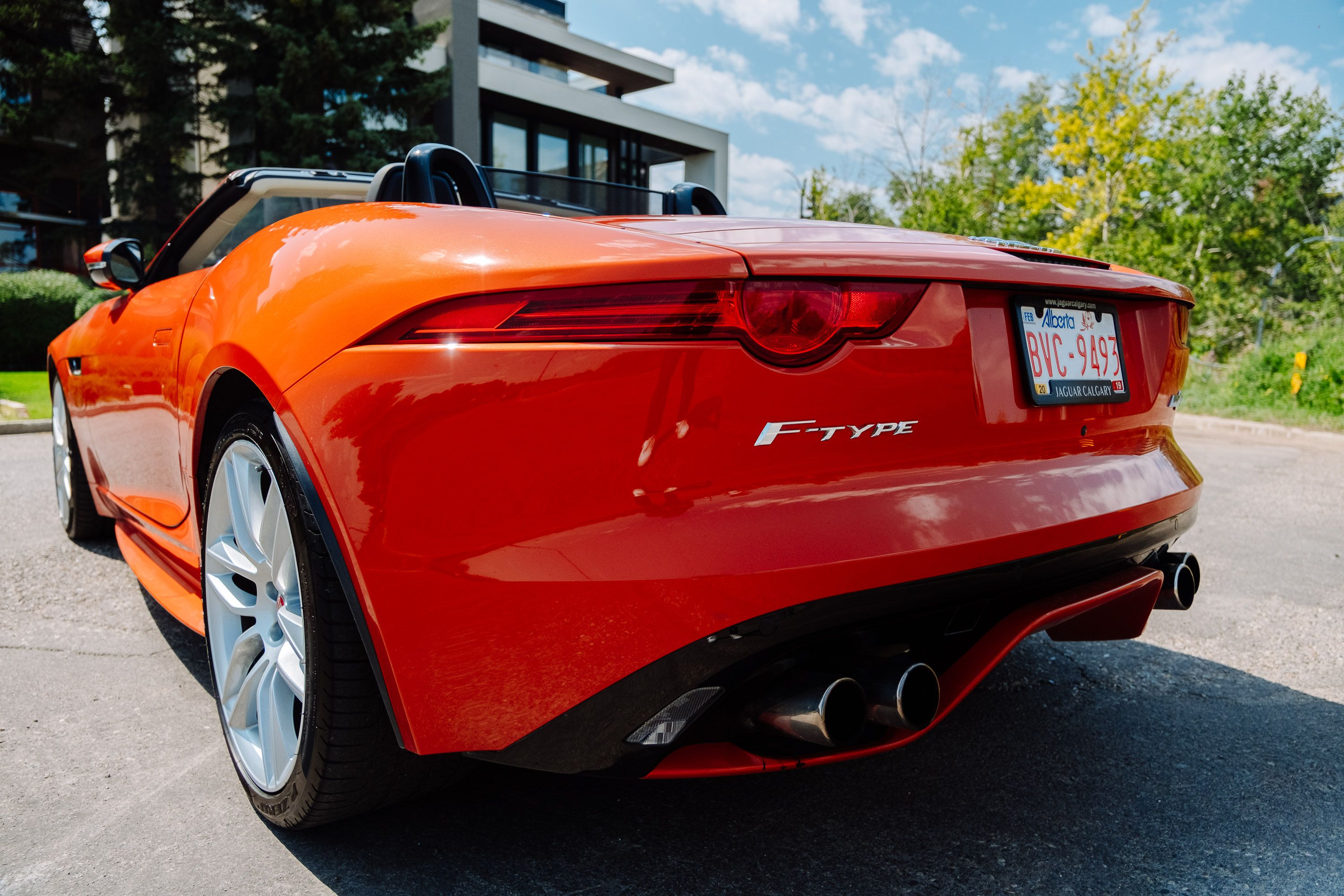 Rear View of a Vibrant Orange Jaguar F-Type Convertible · Free Stock Photo