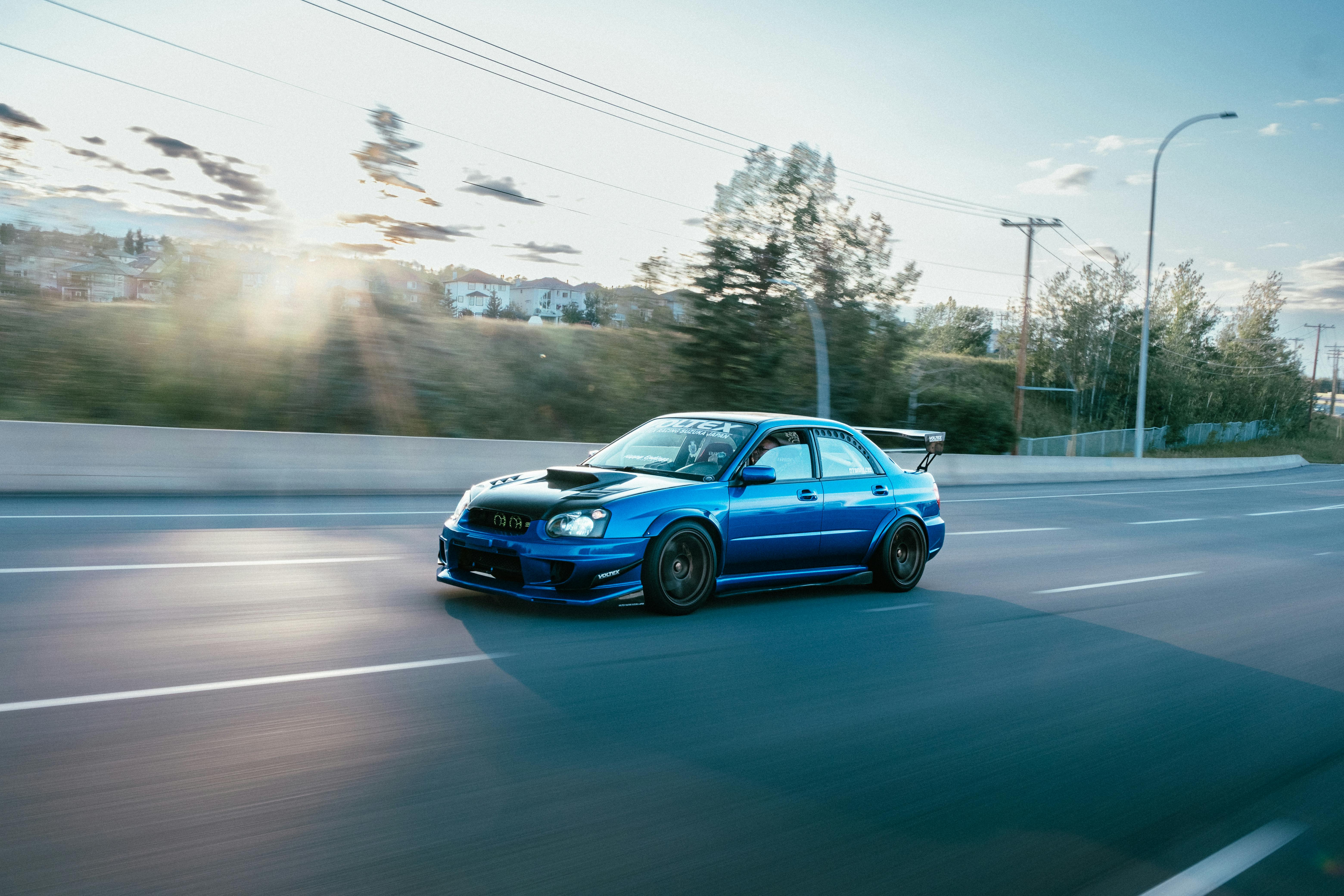 Vibrant Blue Modified Car on Urban Road · Free Stock Photo