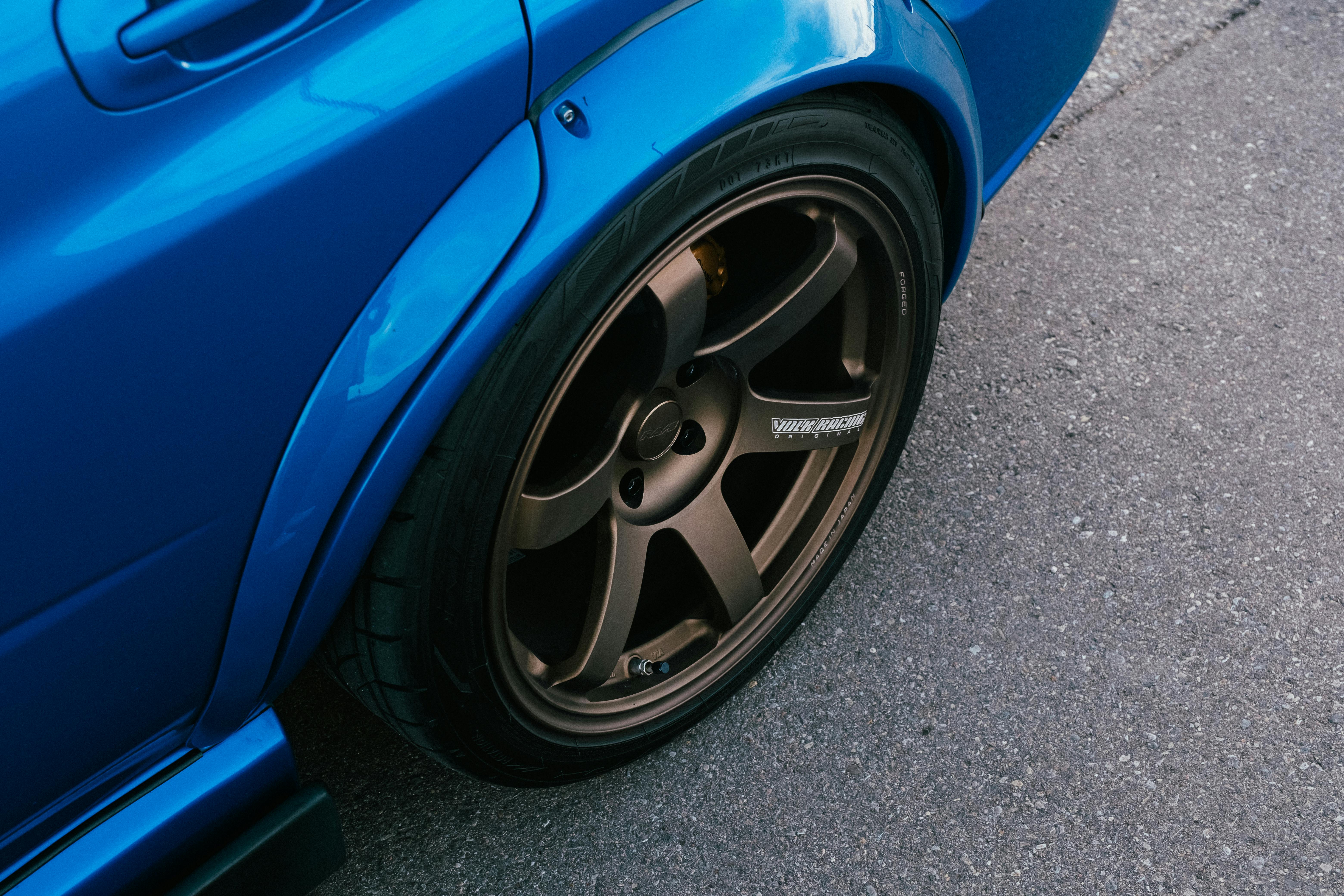 Close-up of Blue Modified Car Wheel on Asphalt · Free Stock Photo