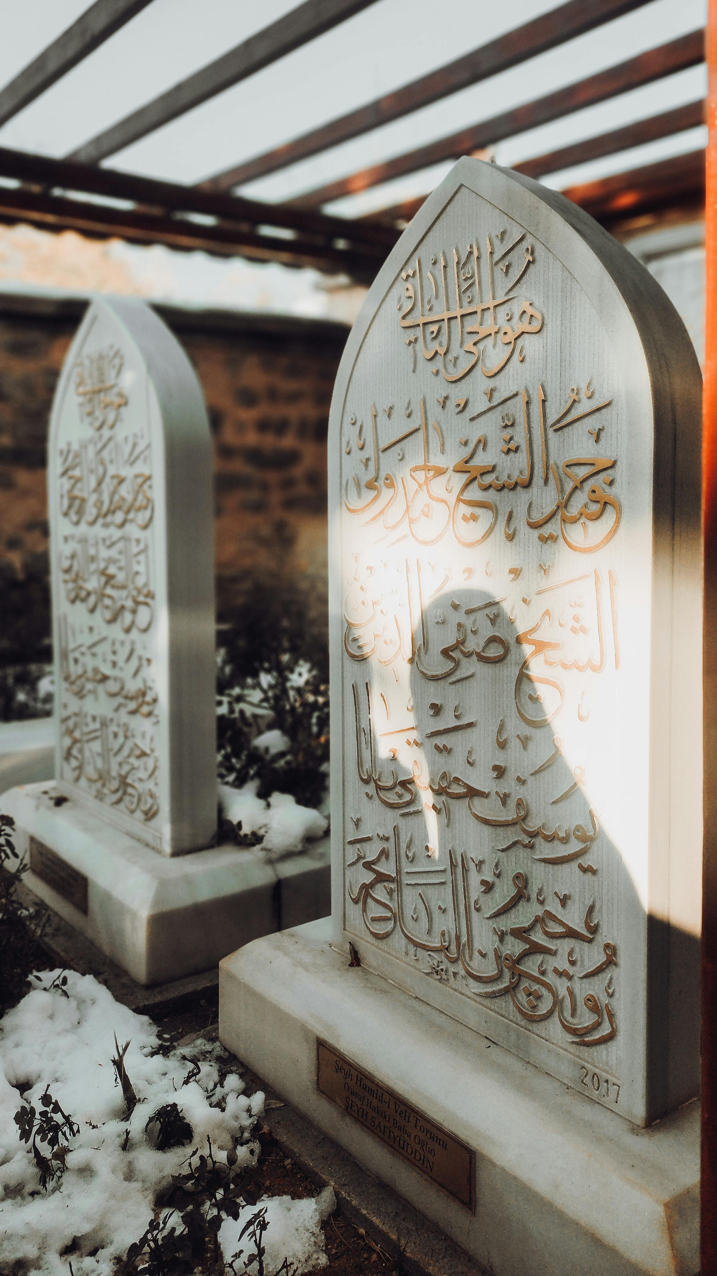 Snow-Covered Marble Tombstones with Arabic Script · Free Stock Photo