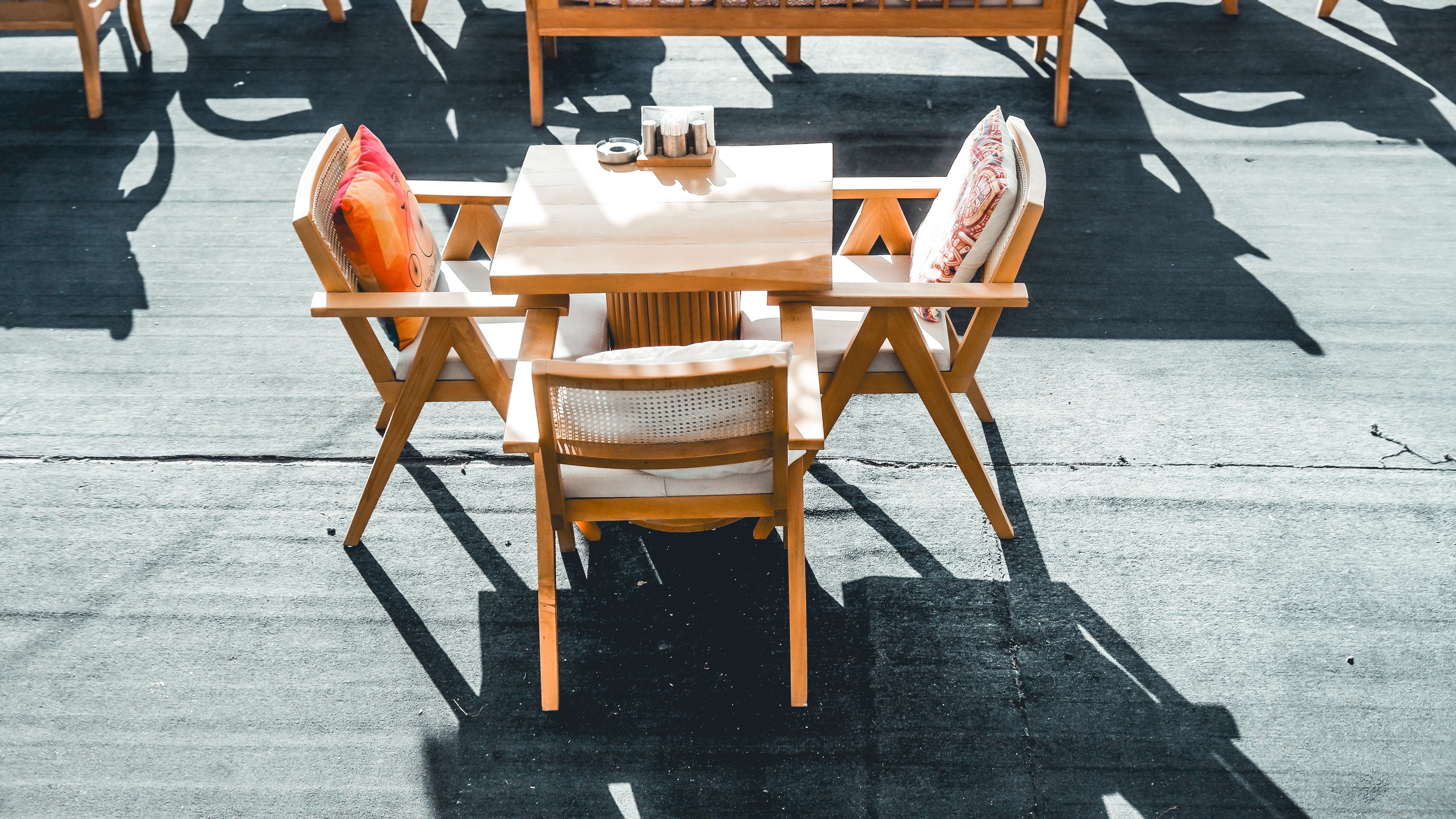 Sunny Outdoor Dining Set with Wooden Chairs · Free Stock Photo