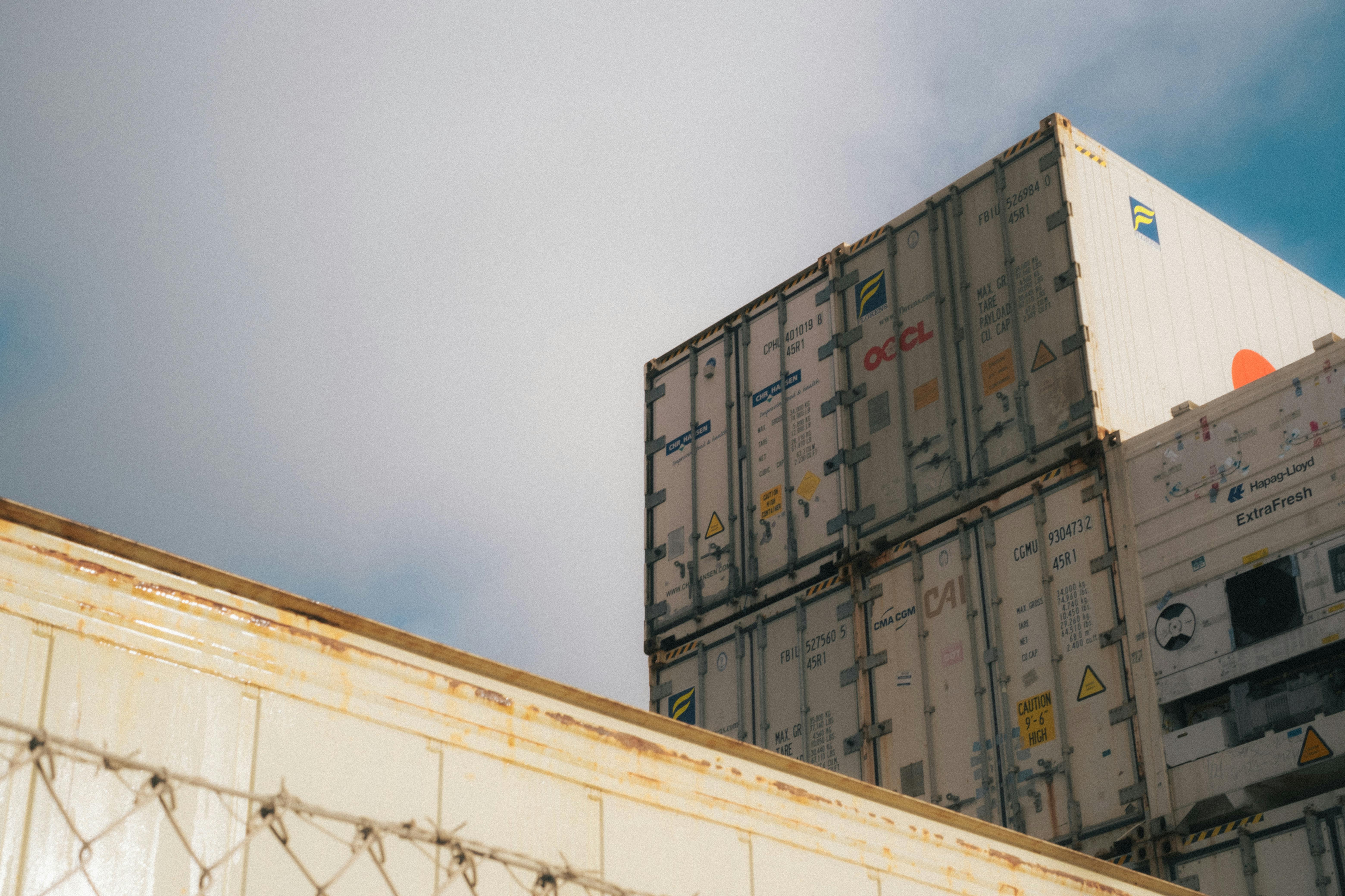 Stacked Shipping Containers Under Cloudy Sky · Free Stock Photo