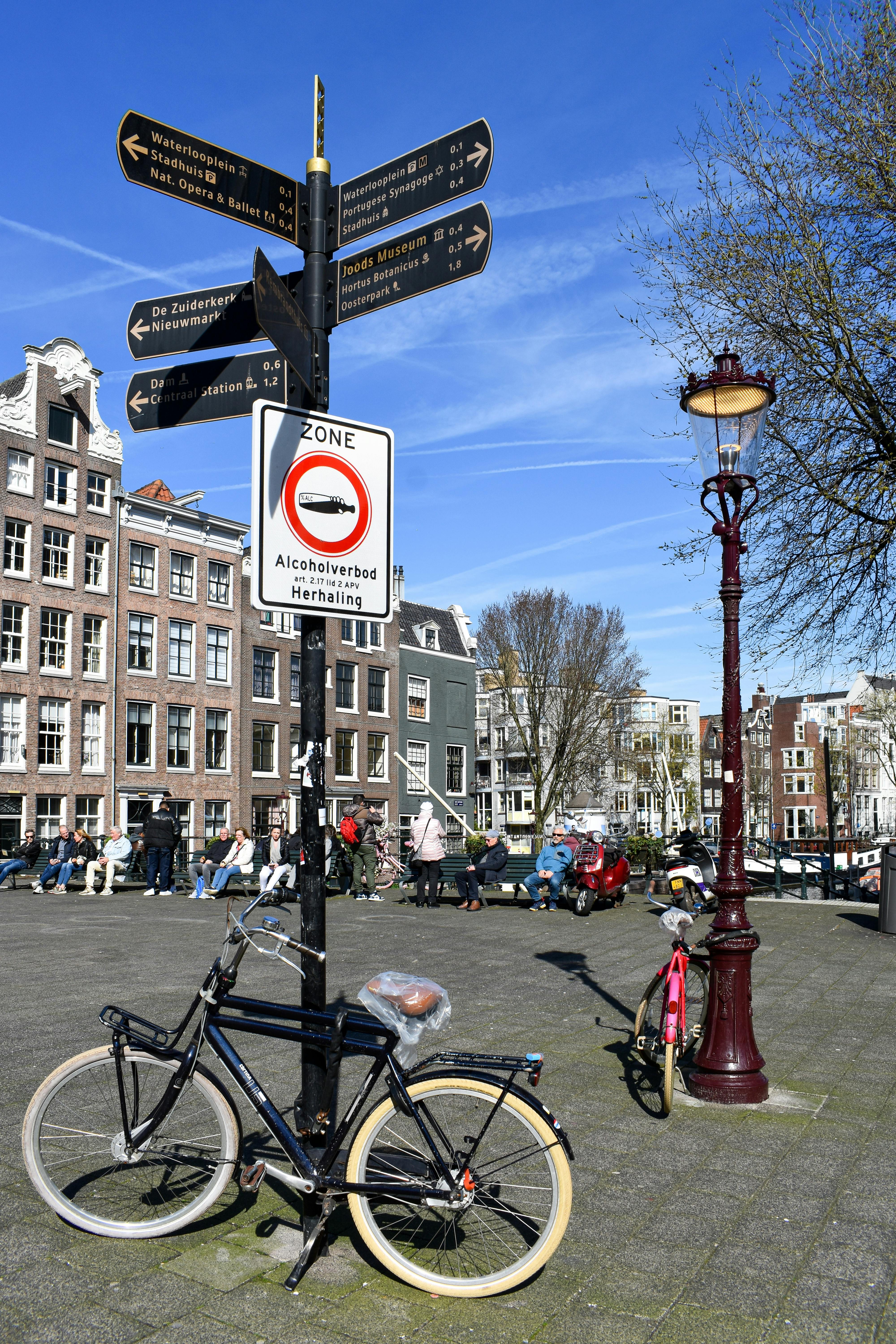 Bicycles and Signpost in Amsterdam City Center · Free Stock Photo