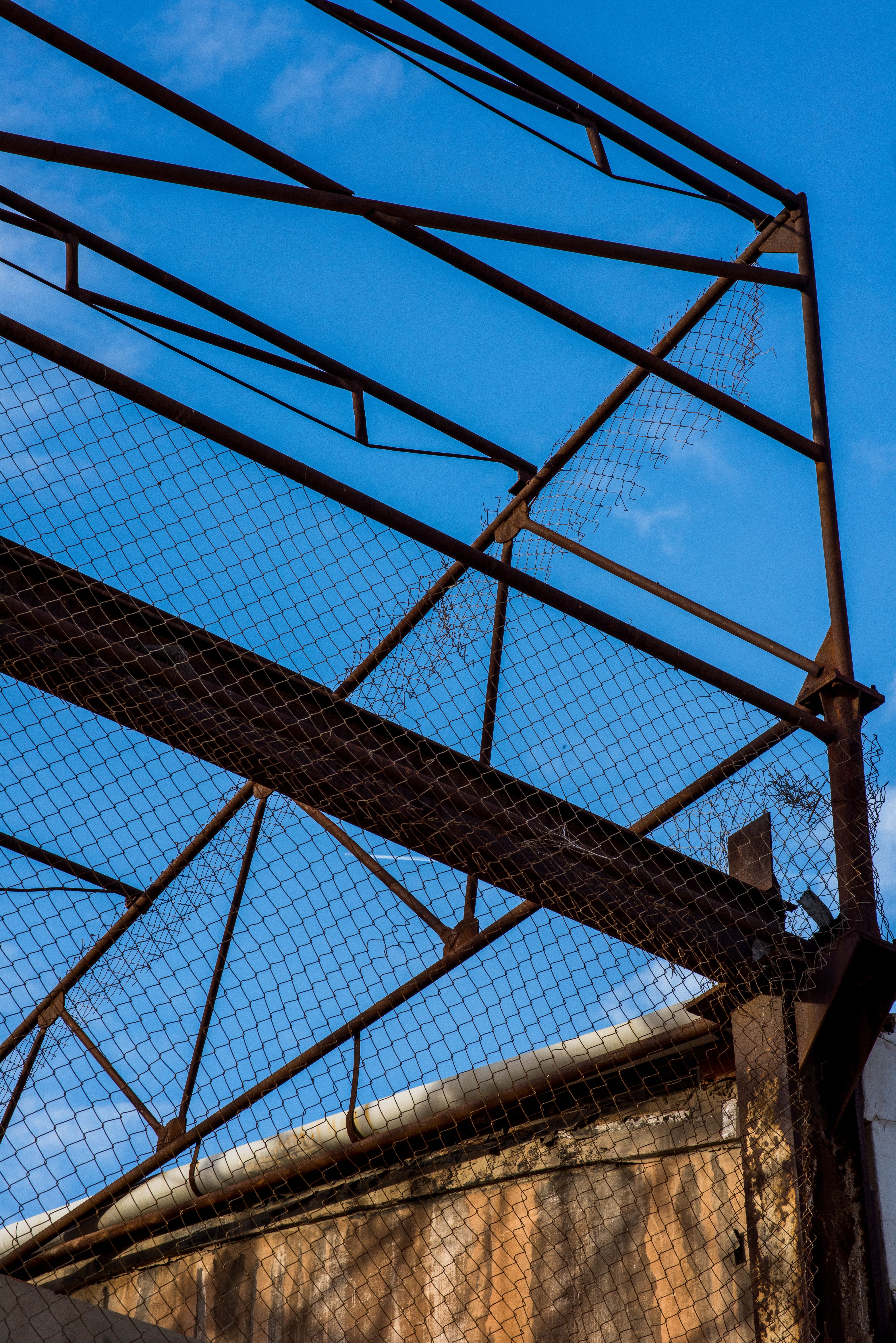 Industrial Rusted Metal Framework Against Blue Sky · Free Stock Photo