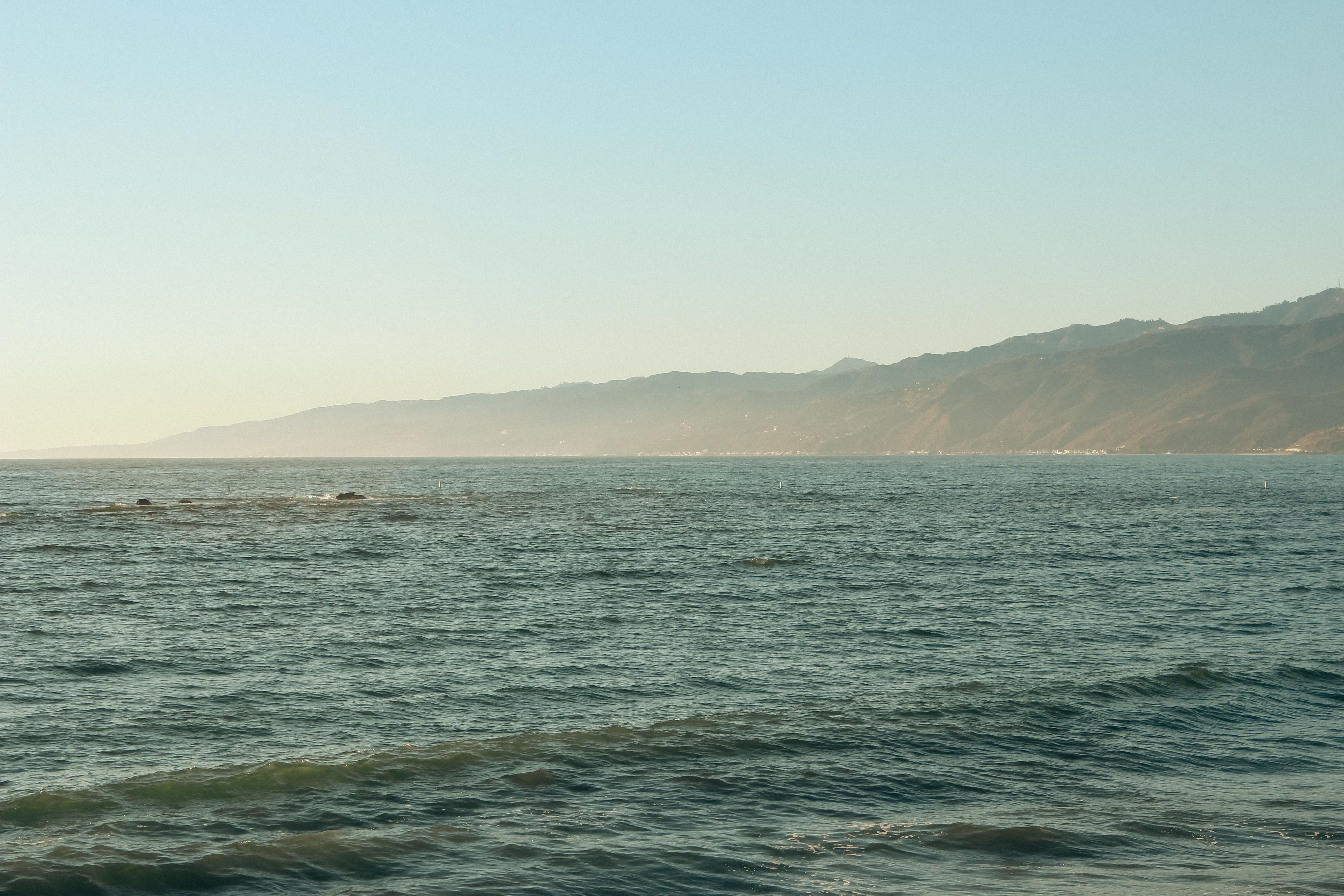 Tranquil Ocean View with Distant Mountains · Free Stock Photo