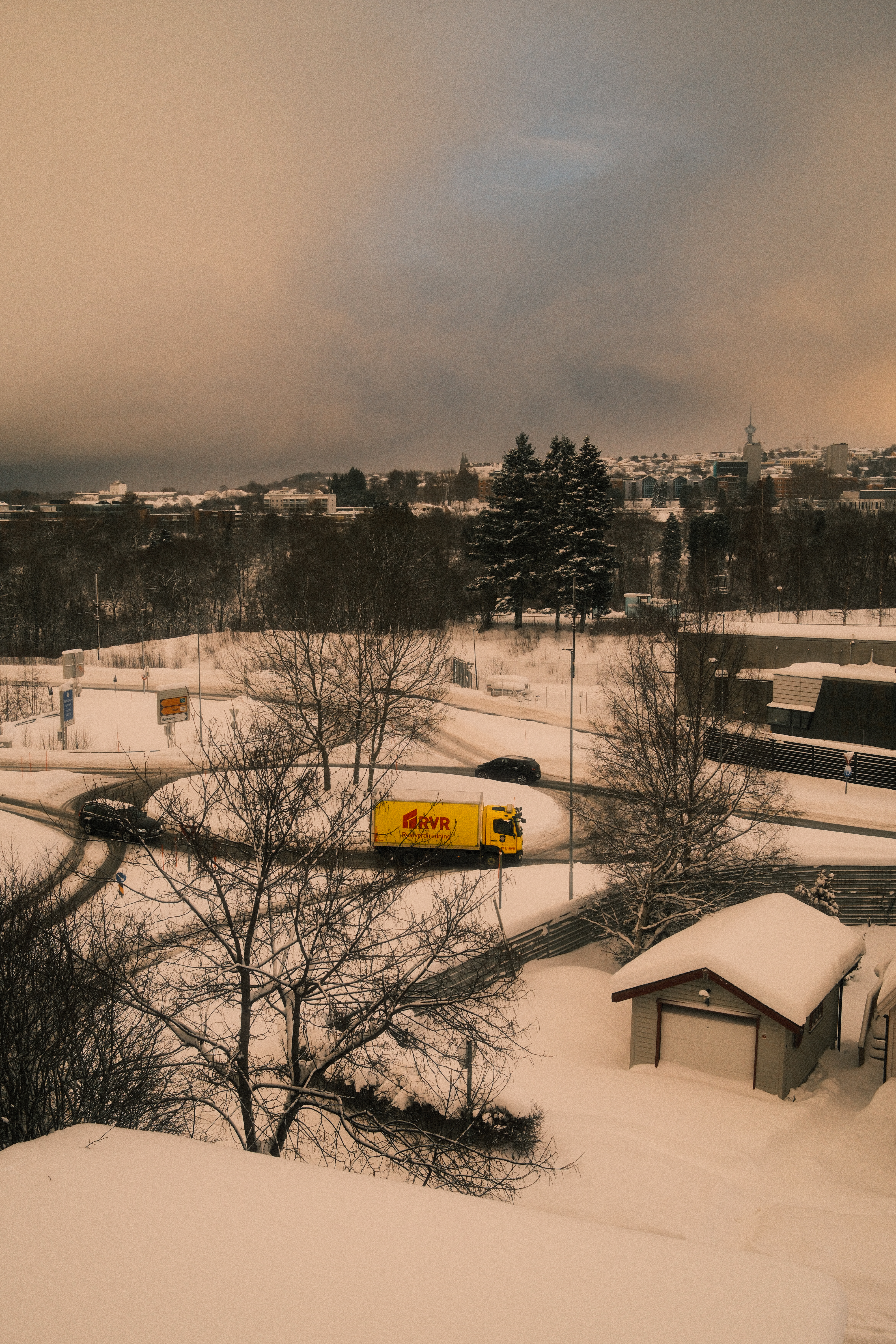 Snowy Urban Landscape with Yellow Truck · Free Stock Photo