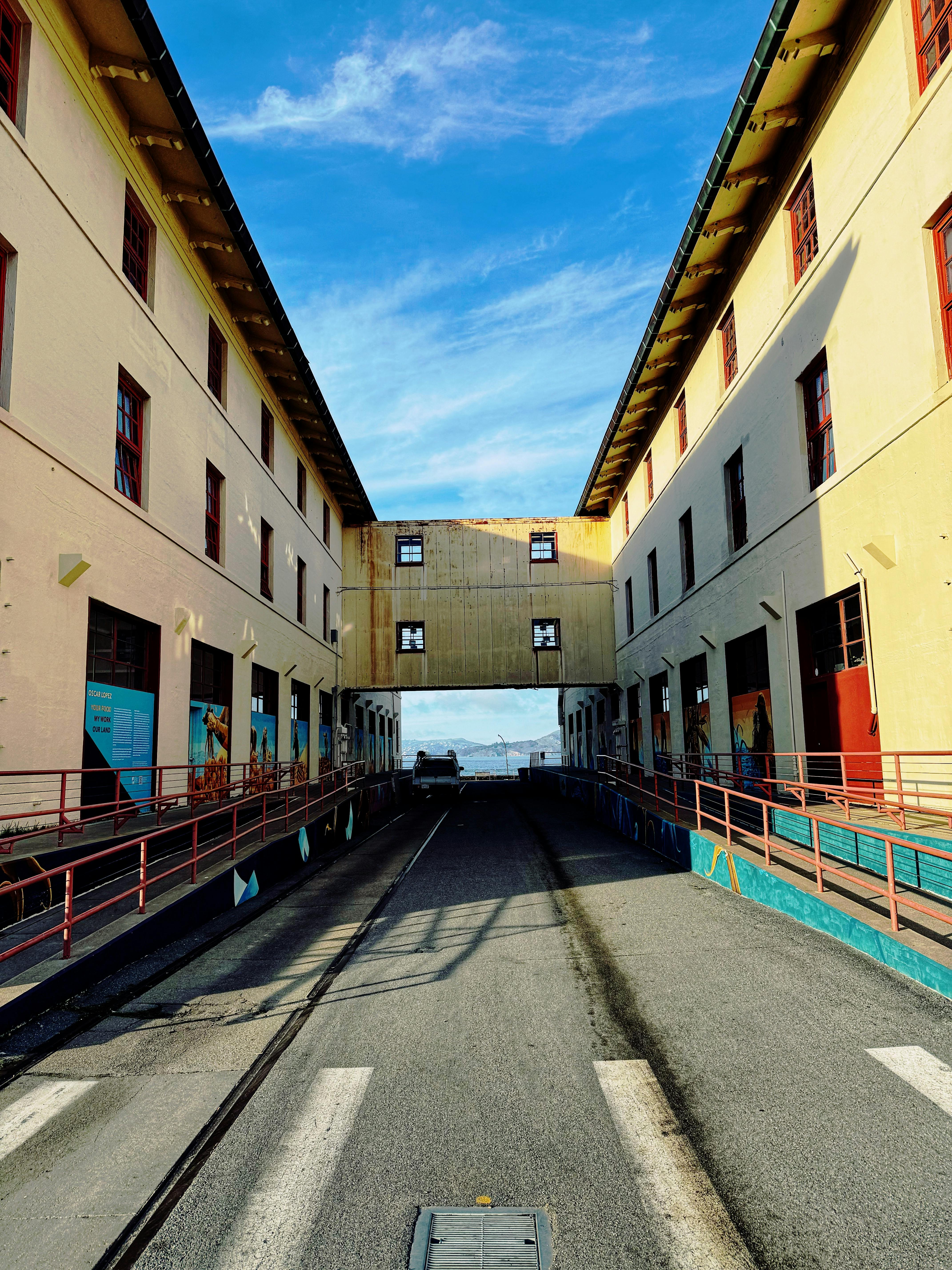 Urban Alleyway with Bridge and Clear Sky · Free Stock Photo