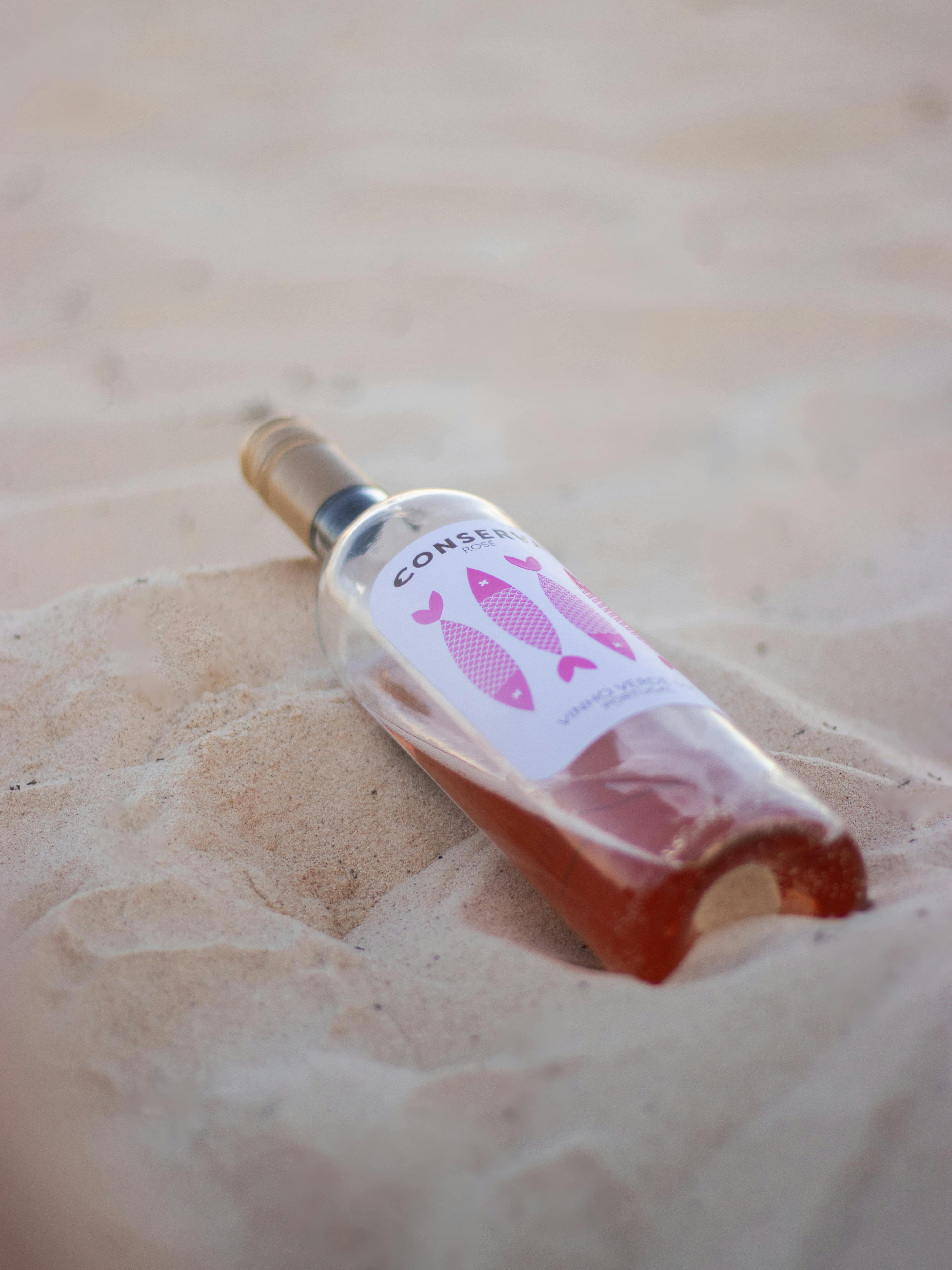 Chilled Rose Wine Bottle on Sandy Beach · Free Stock Photo
